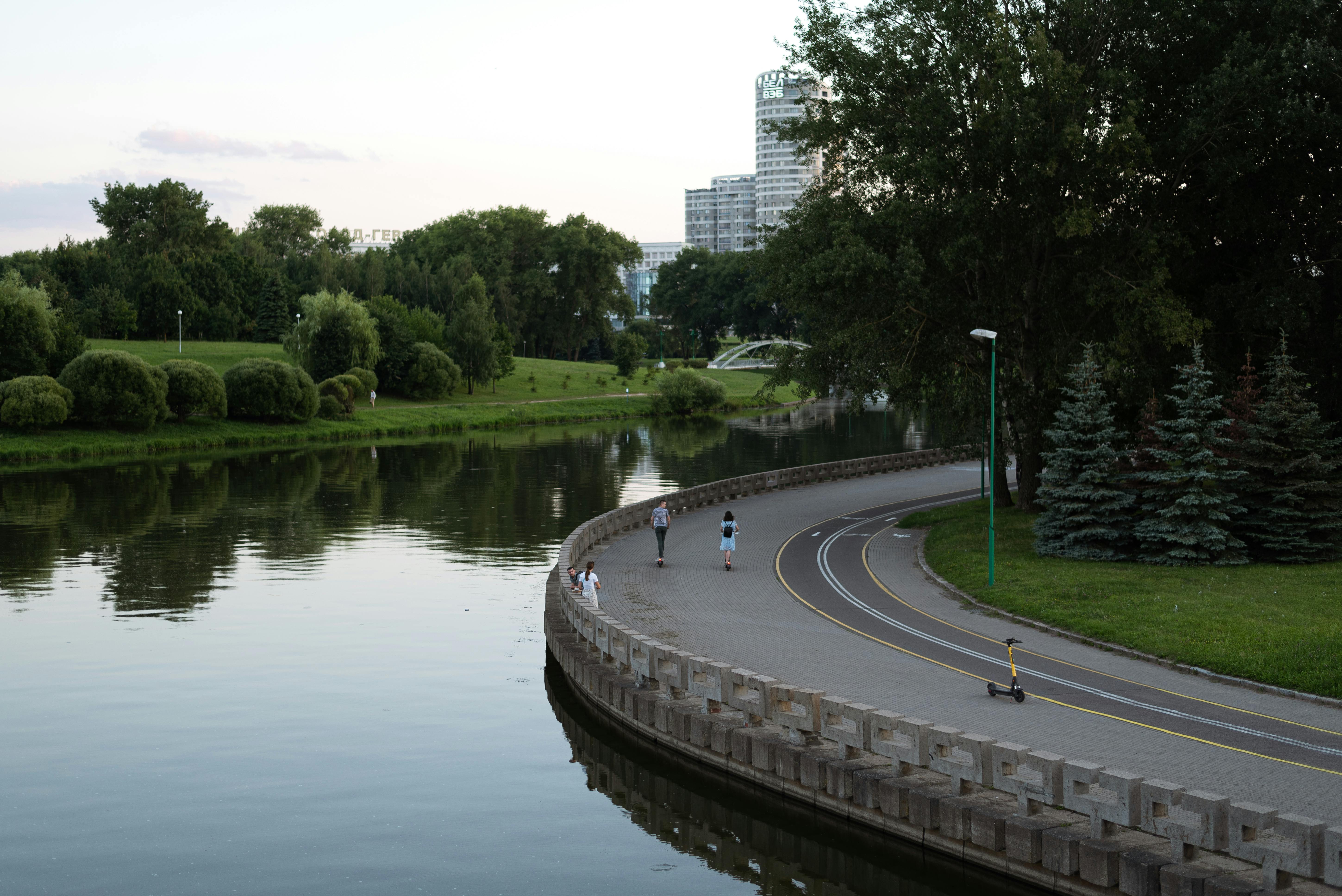 Promenade along River in City Park · Free Stock Photo