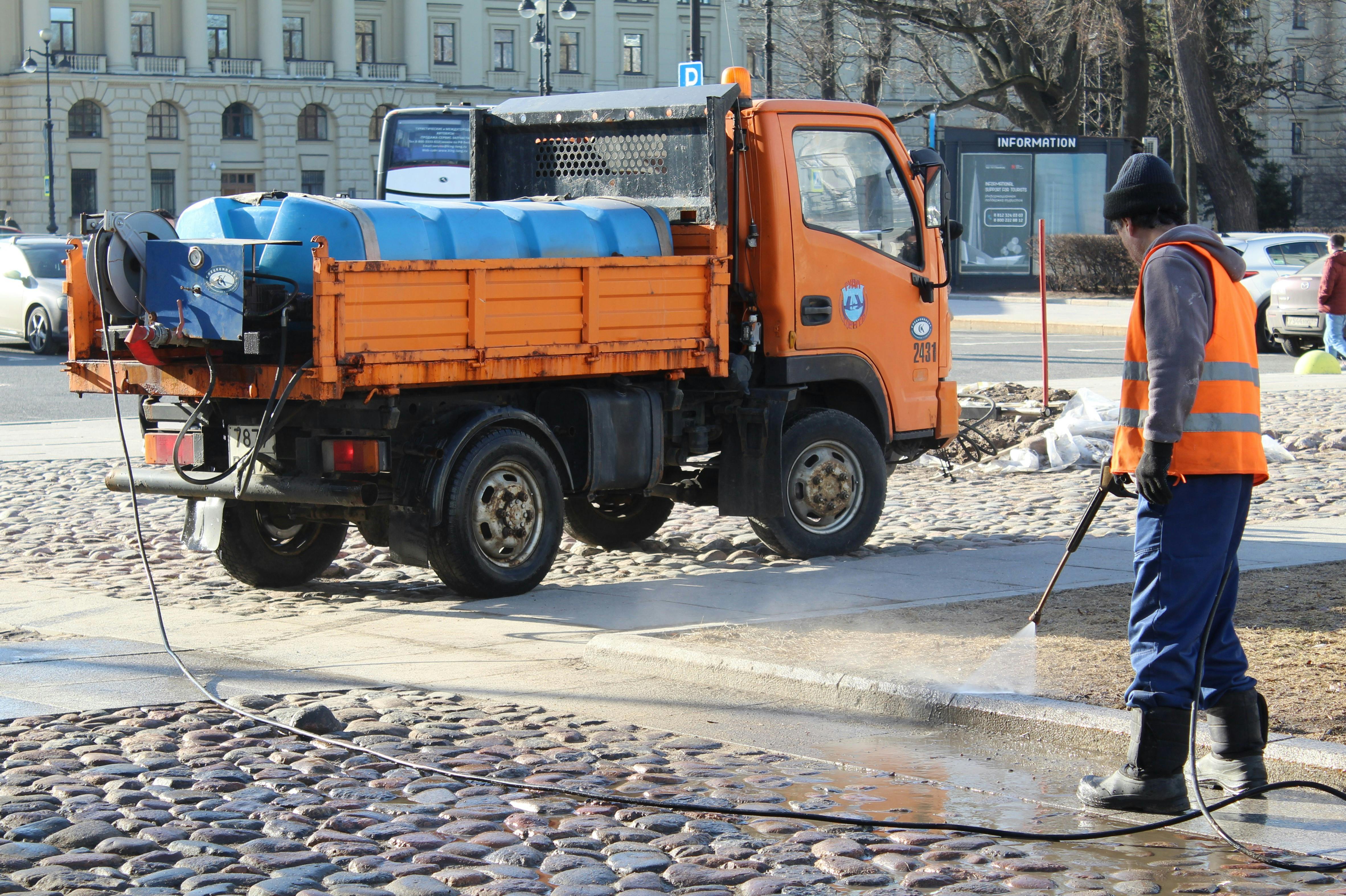 Worker Cleaning Street in City · Free Stock Photo