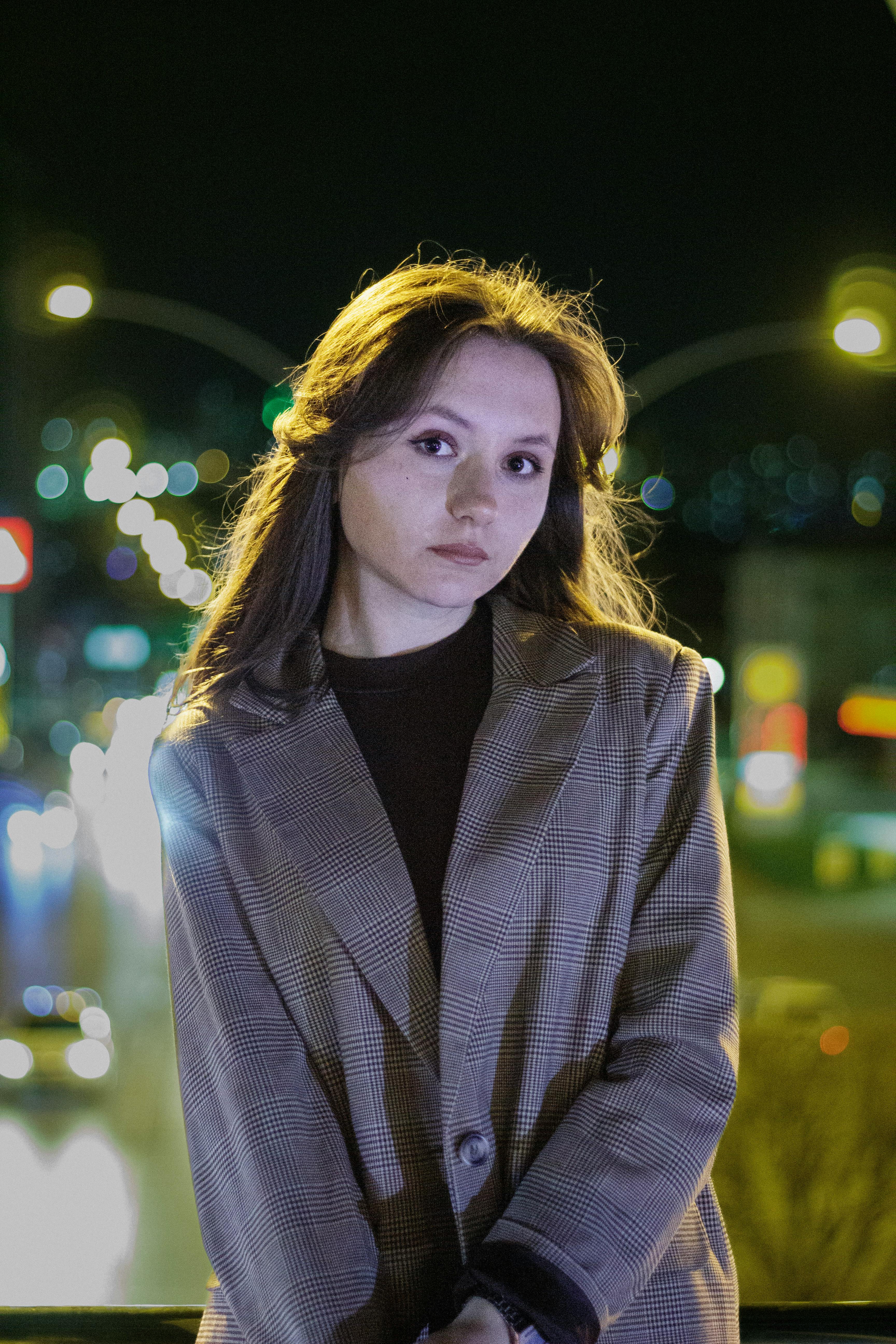 Woman Sitting On The Ledge Of A Rooftop · Free Stock Photo