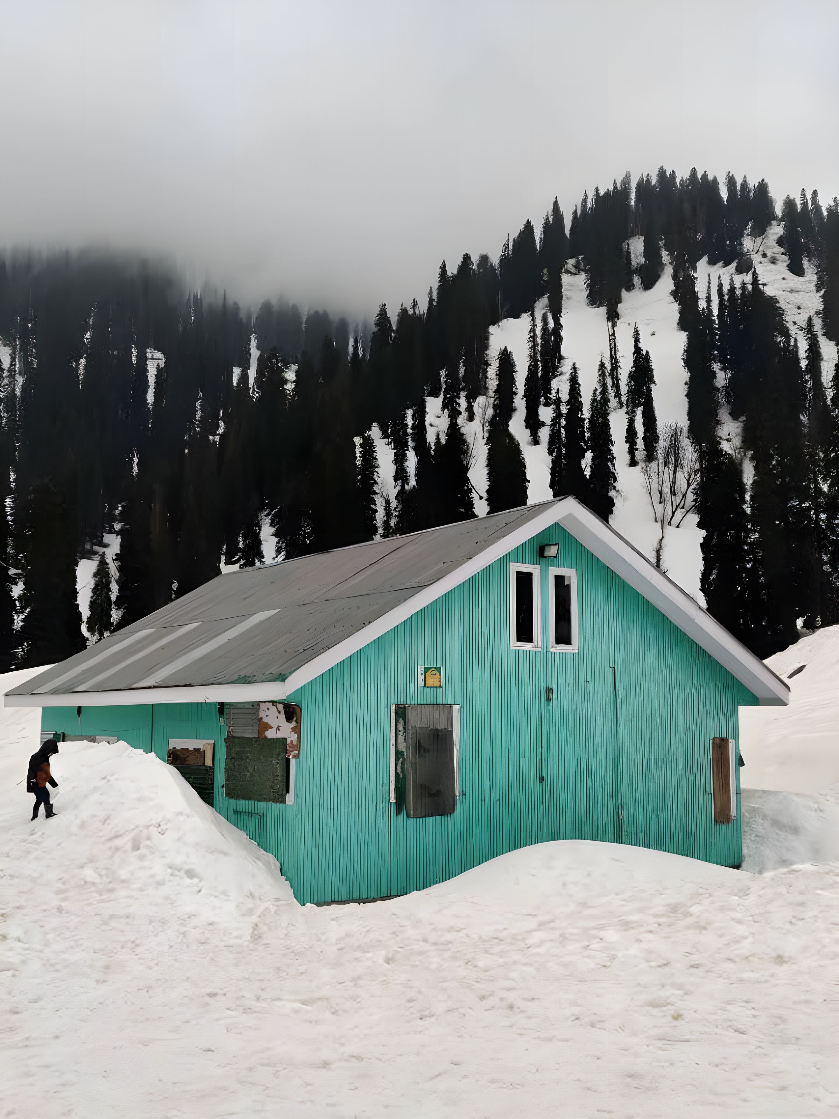 A turquoise building in the snow · Free Stock Photo