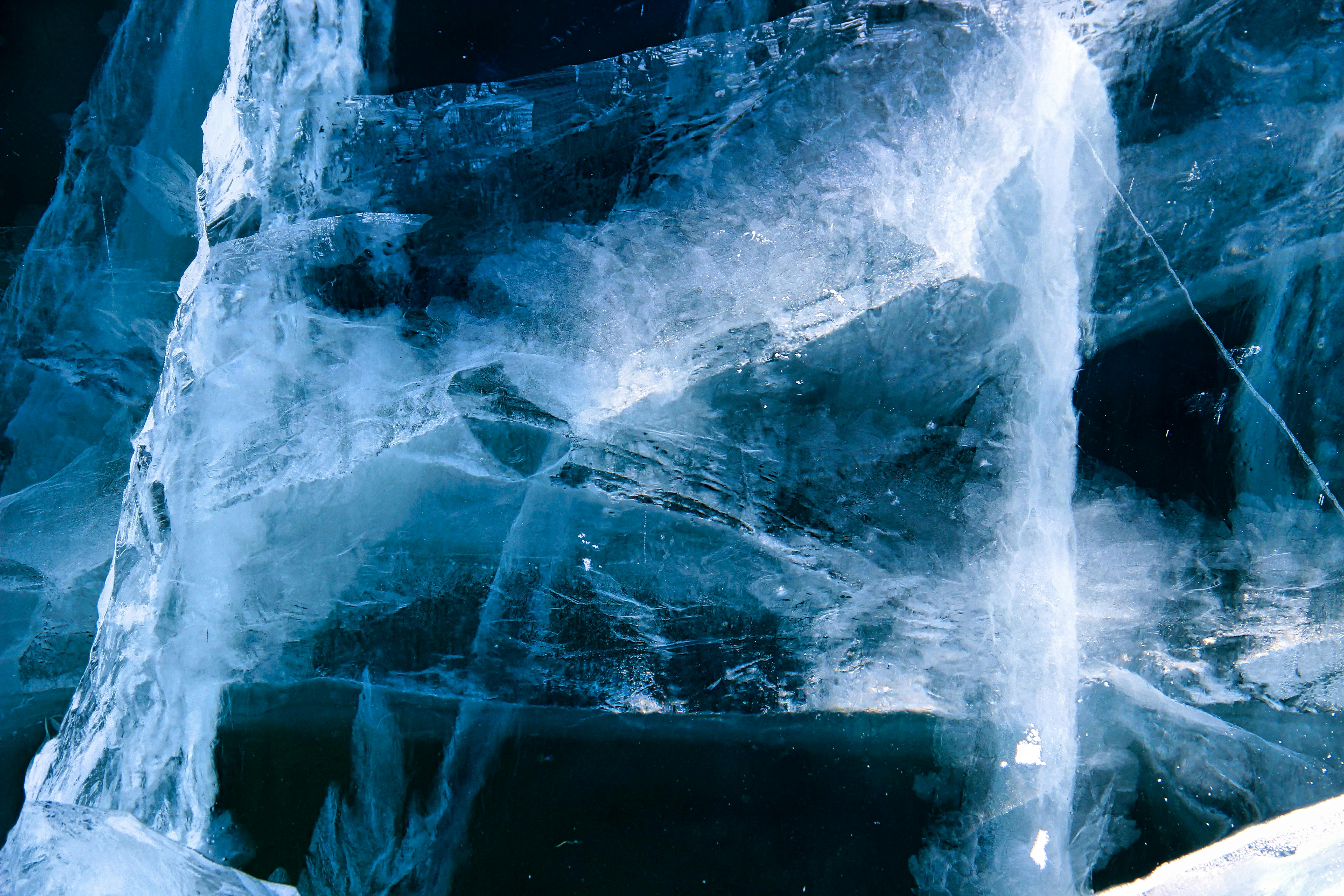 Ice and water in the dark with blue and white ice · Free Stock Photo