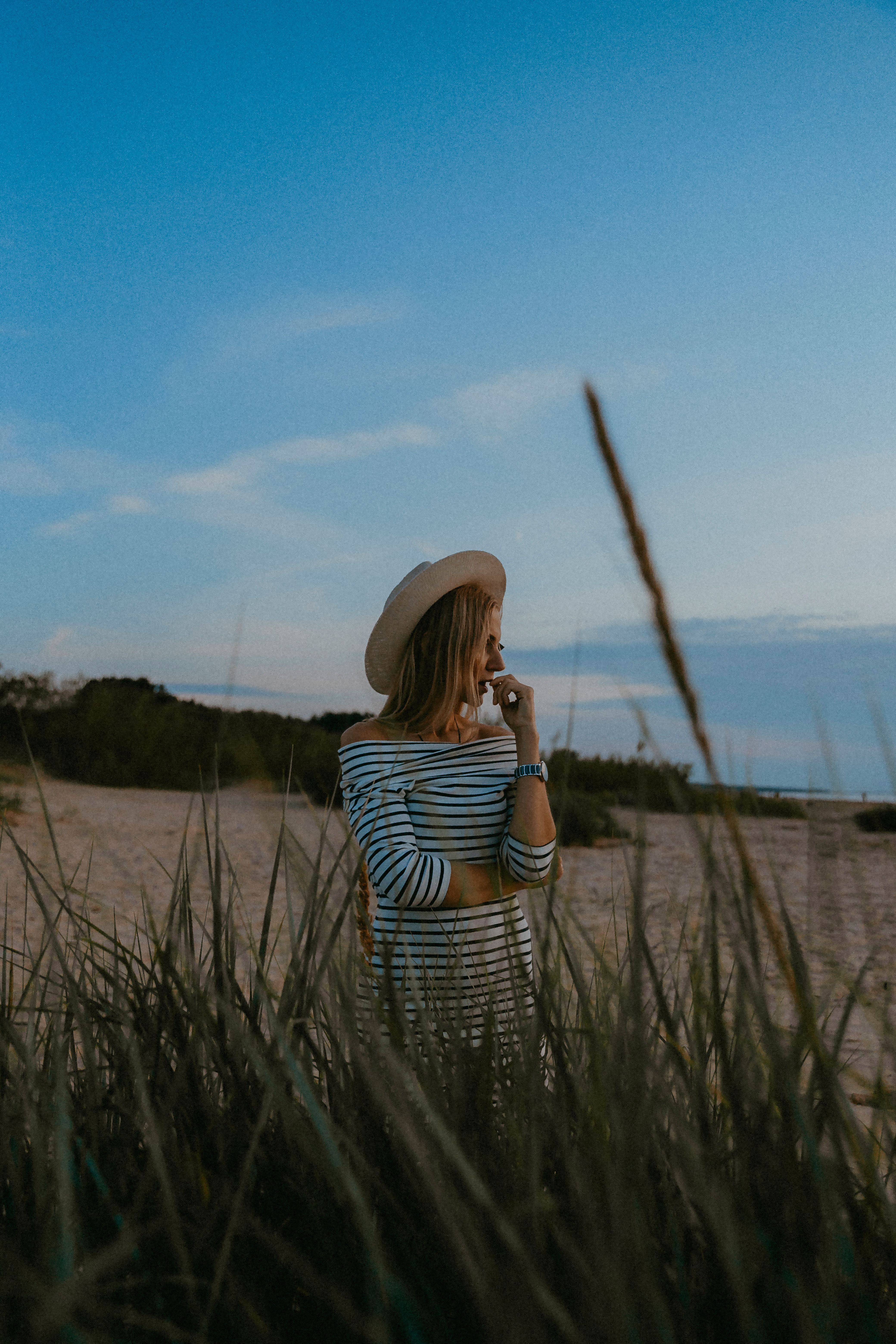 Woman in black dress overlooking ocean · Free Stock Photo