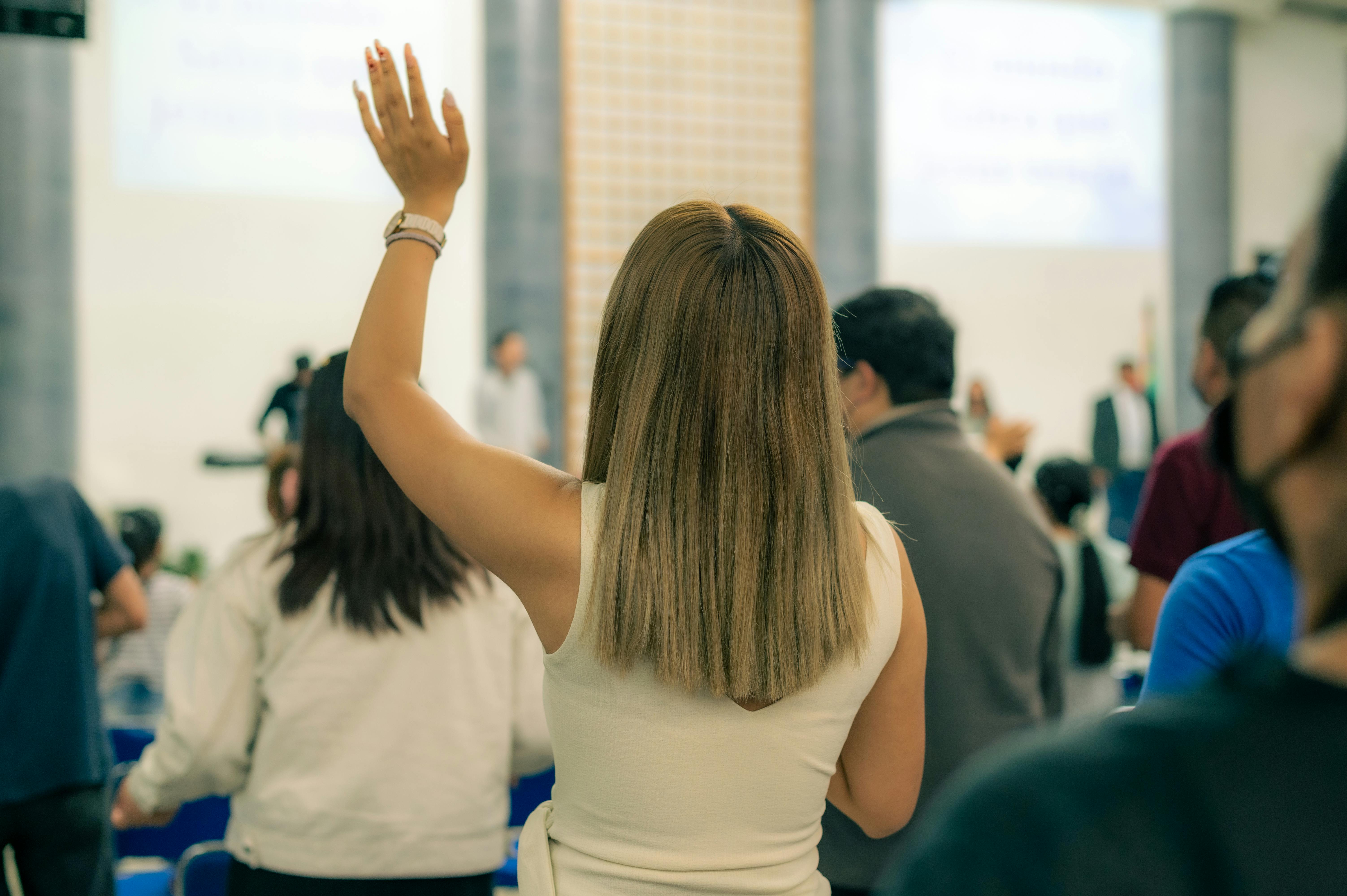 A Woman Raising her Hand · Free Stock Photo