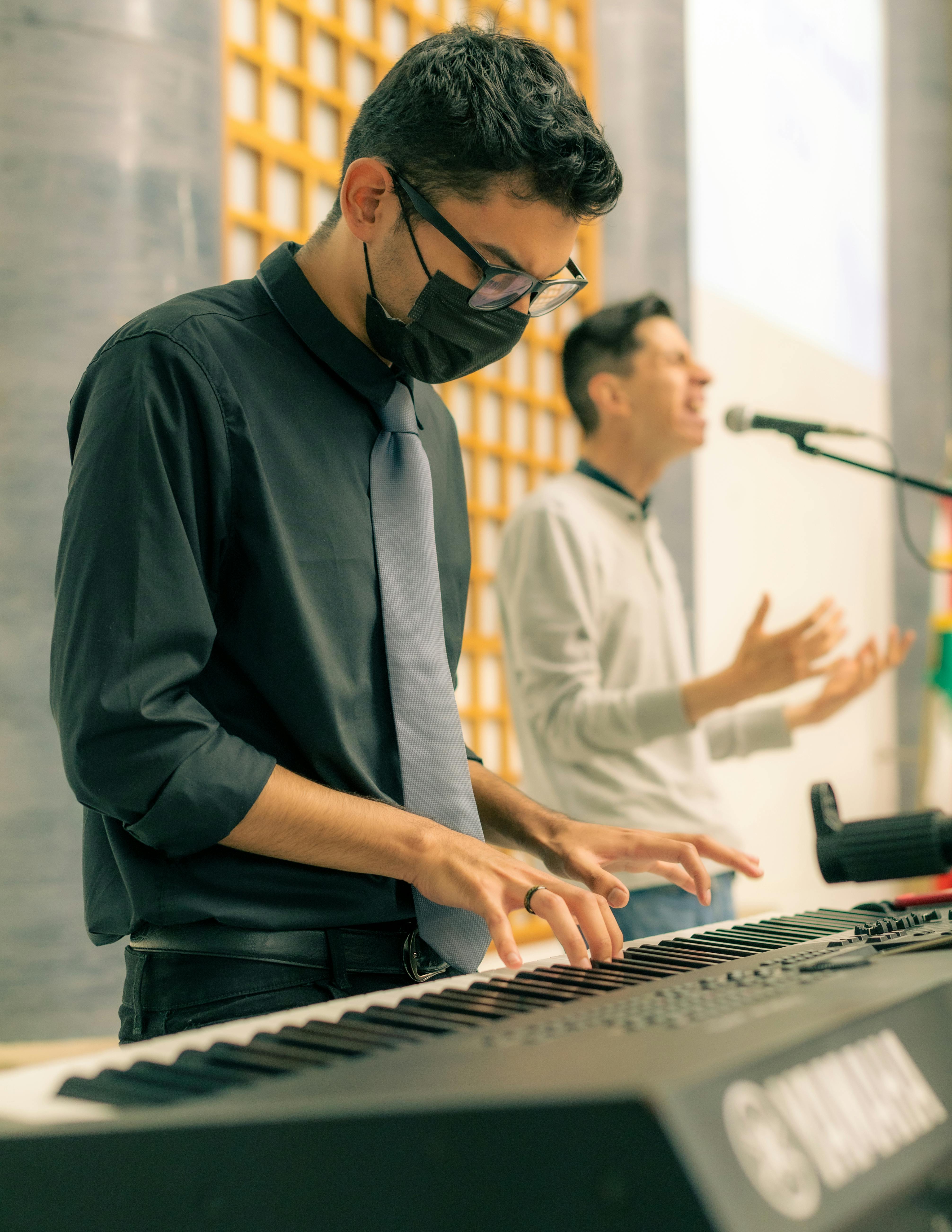 Boy in a Face Mask Playing the Keyboard · Free Stock Photo