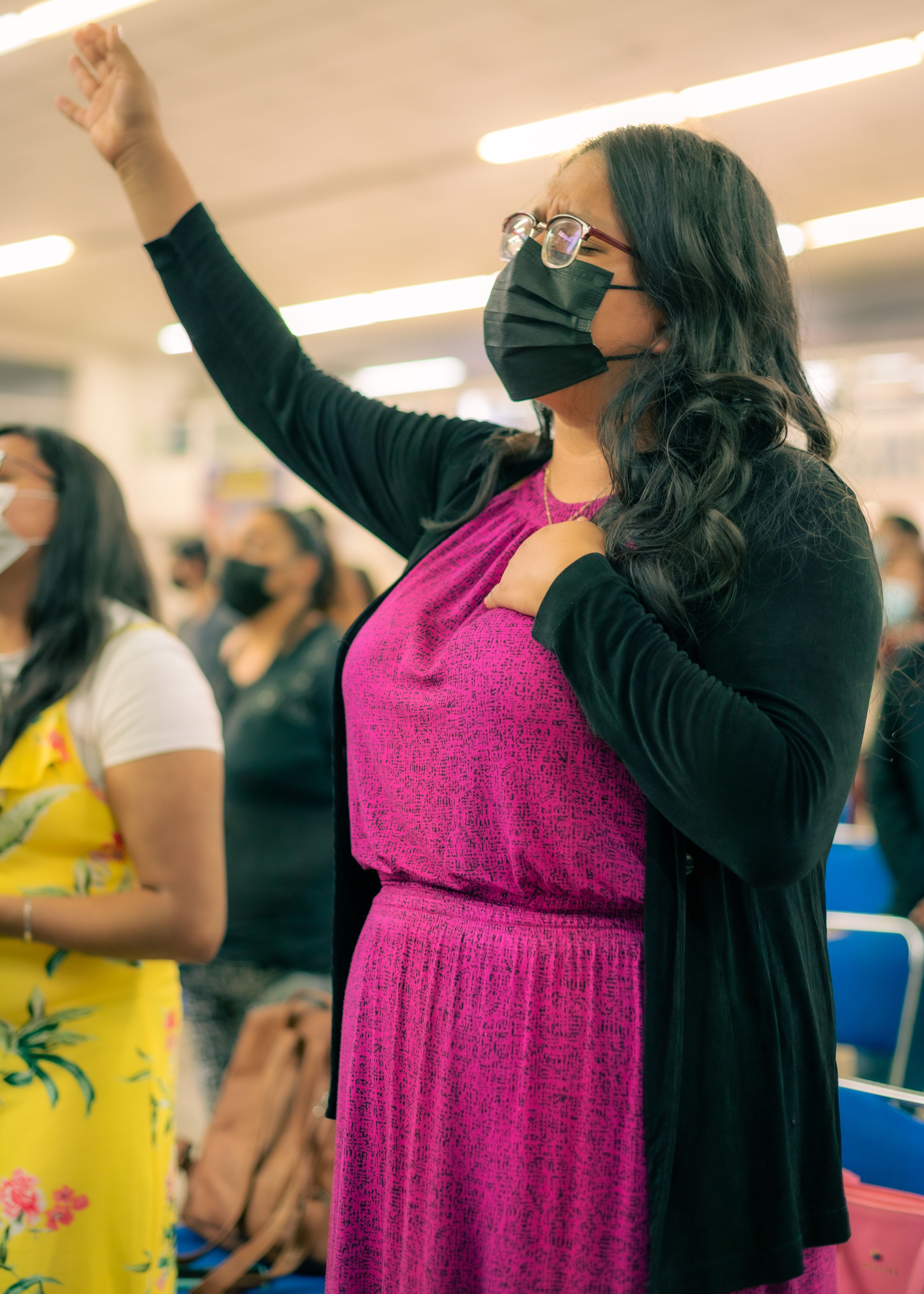 A Group of People in the Audience Standing with Eyes Closed · Free ...