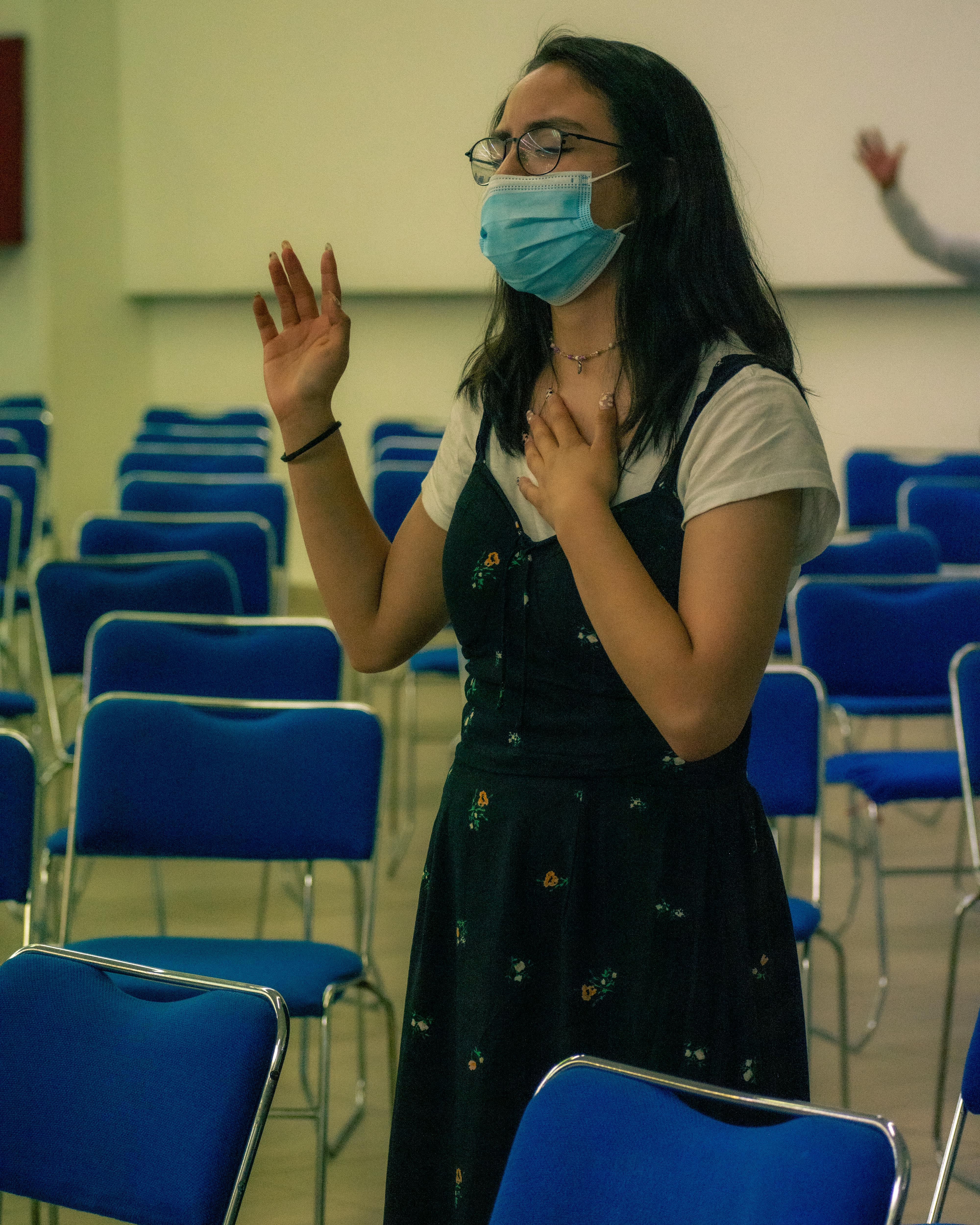 Woman in a Face Mask Holding up her Hand · Free Stock Photo