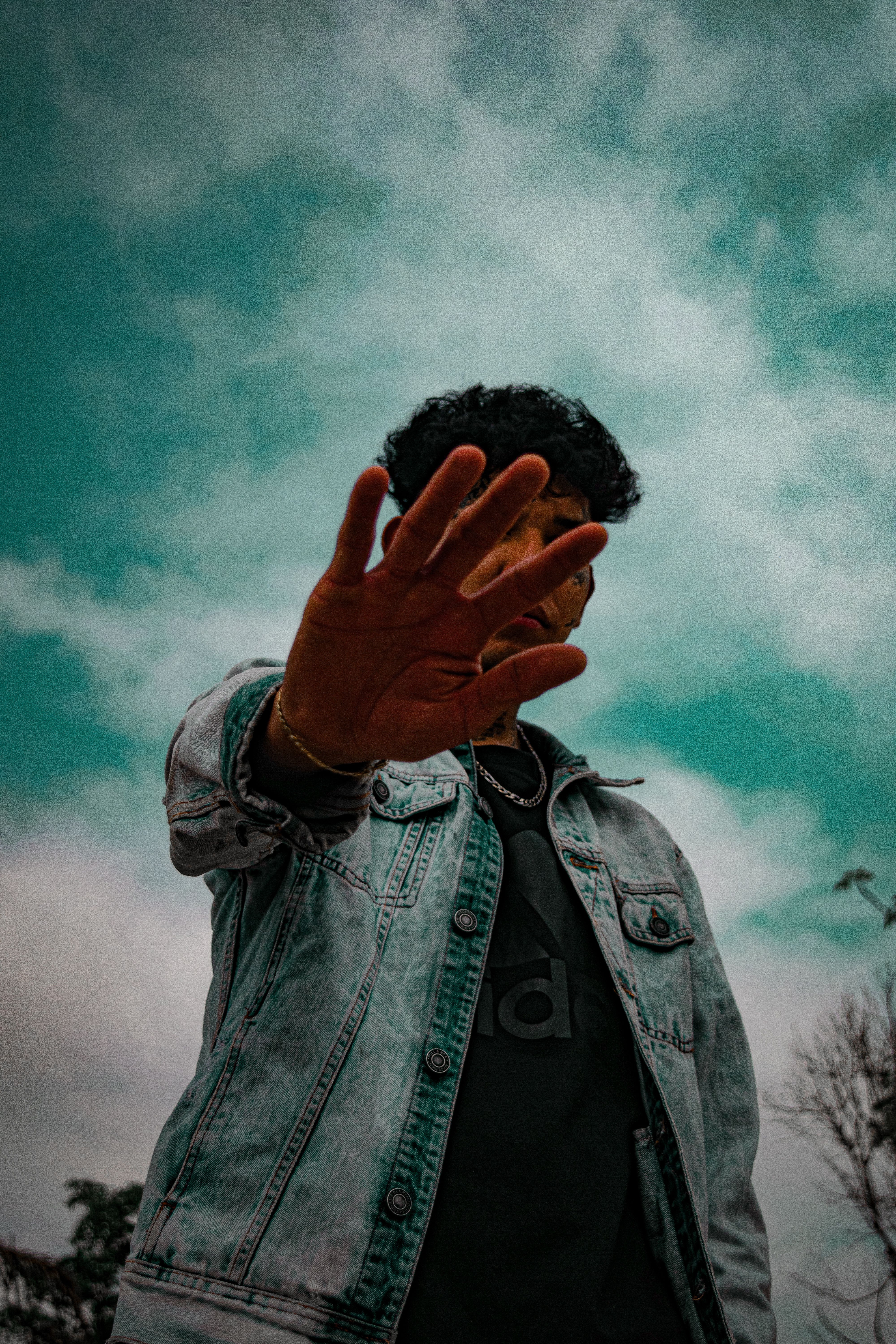 Portrait of Man with Hand Raised · Free Stock Photo