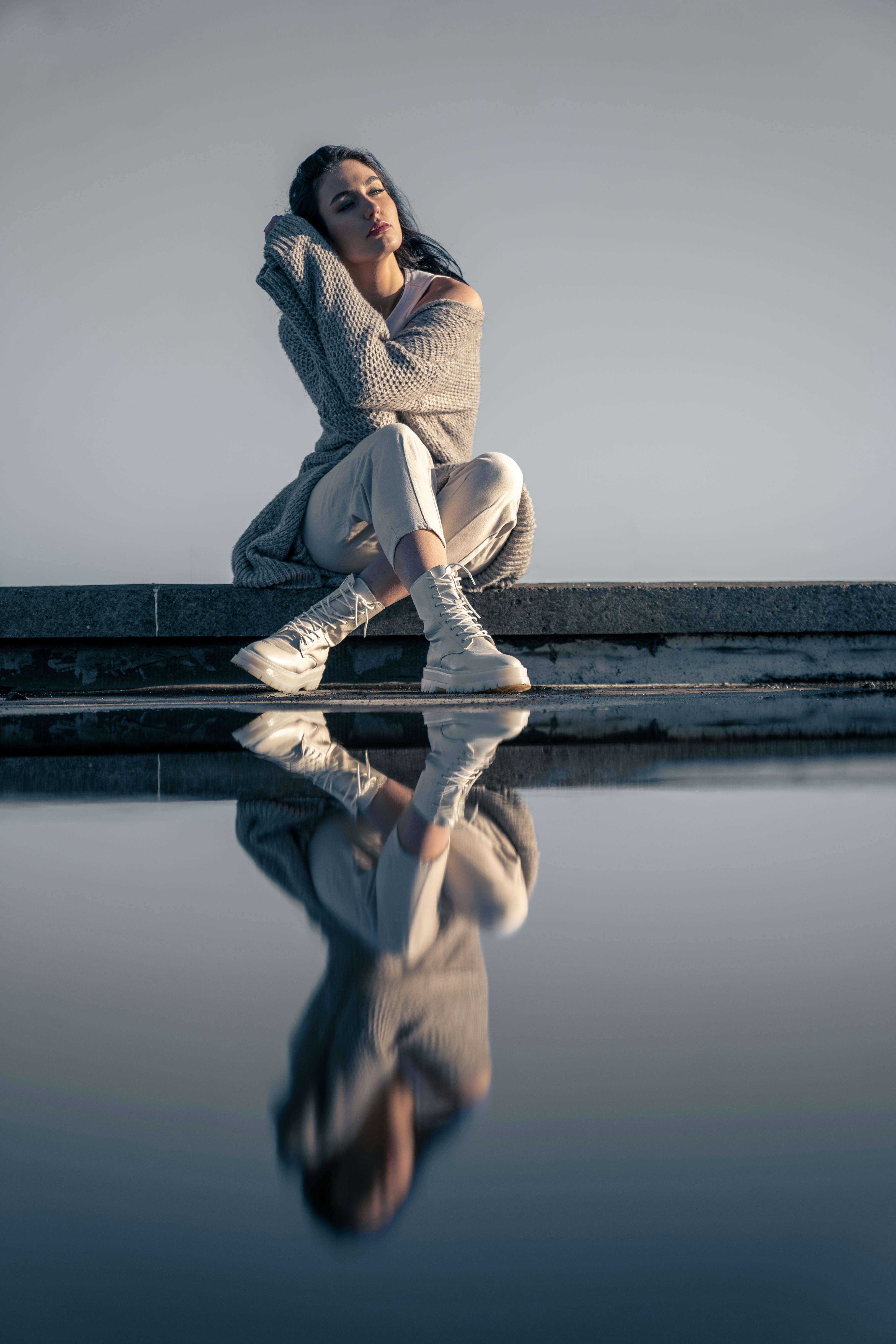 Posing Woman Reflection in Puddle · Free Stock Photo