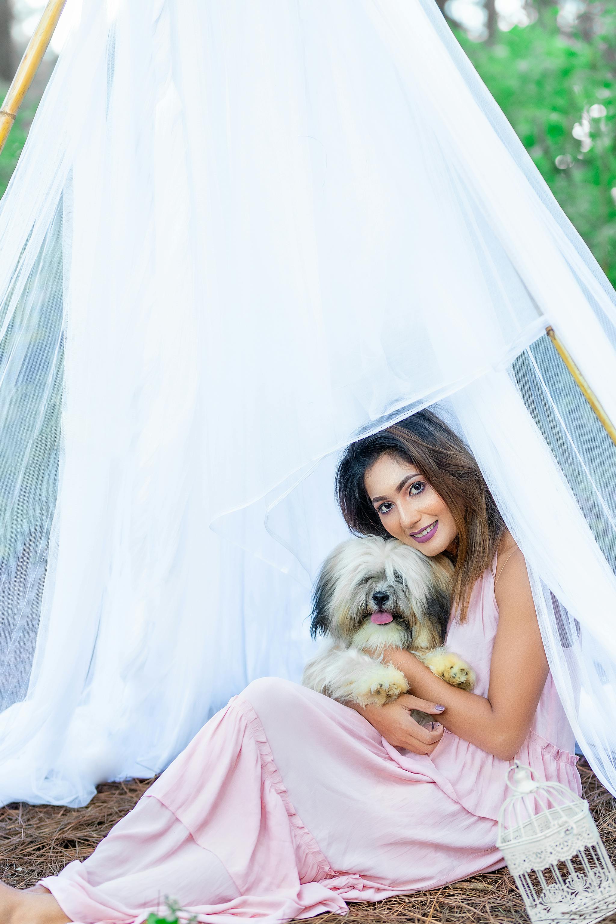 Woman Squatting with Dog in Clothes · Free Stock Photo