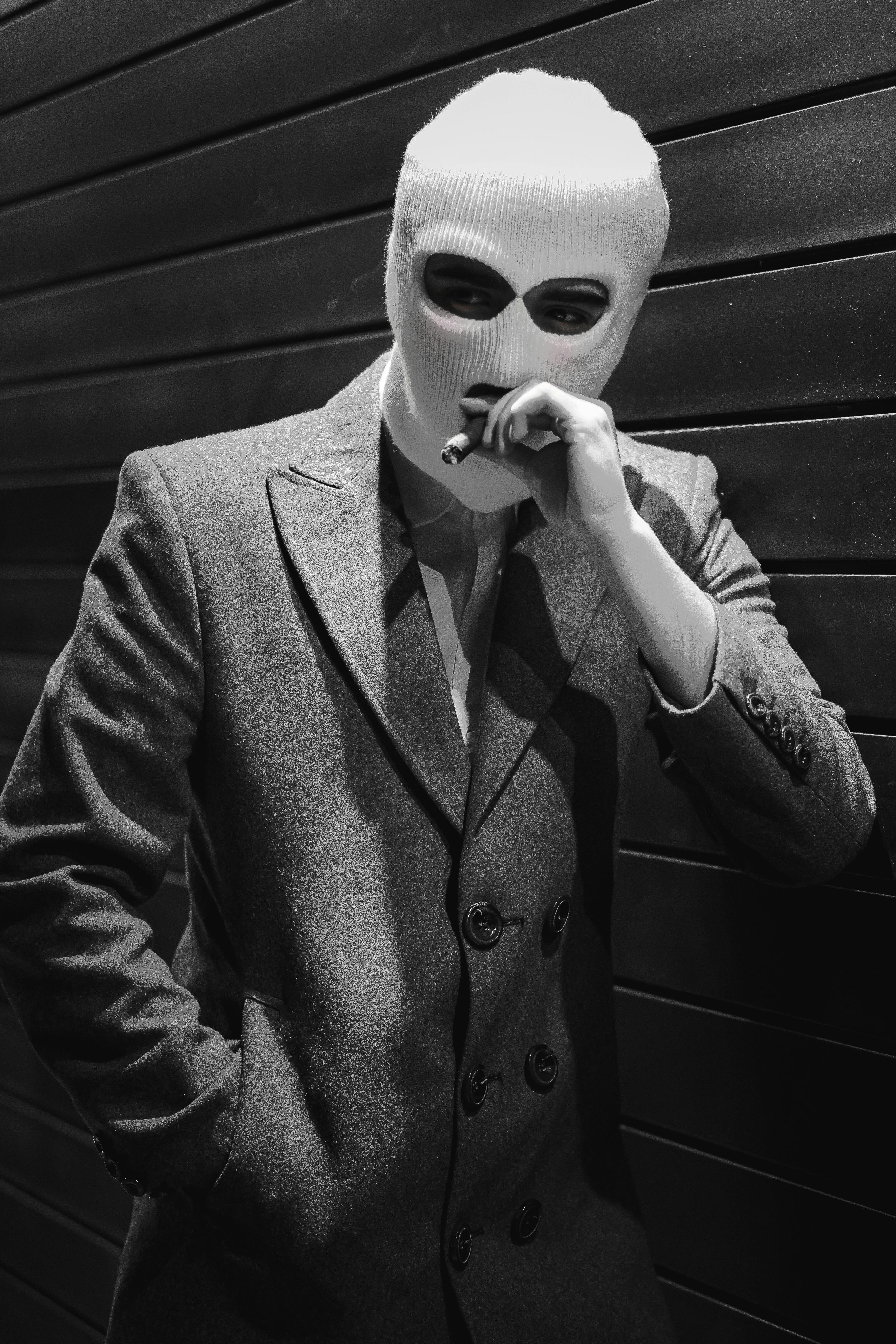 Person in Suit and Balaclava Smoking · Free Stock Photo