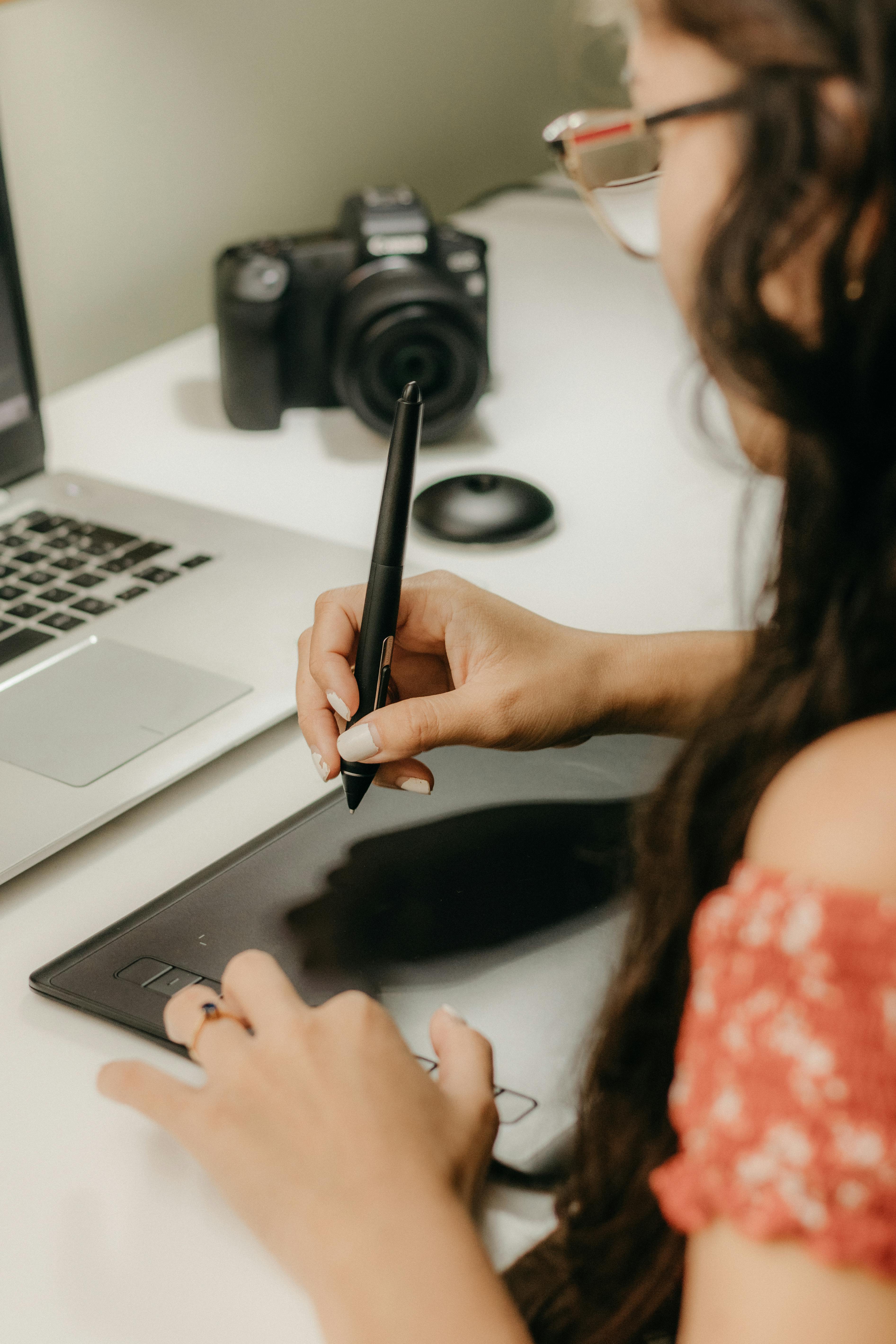 Woman Writing with Pen on Tablet · Free Stock Photo