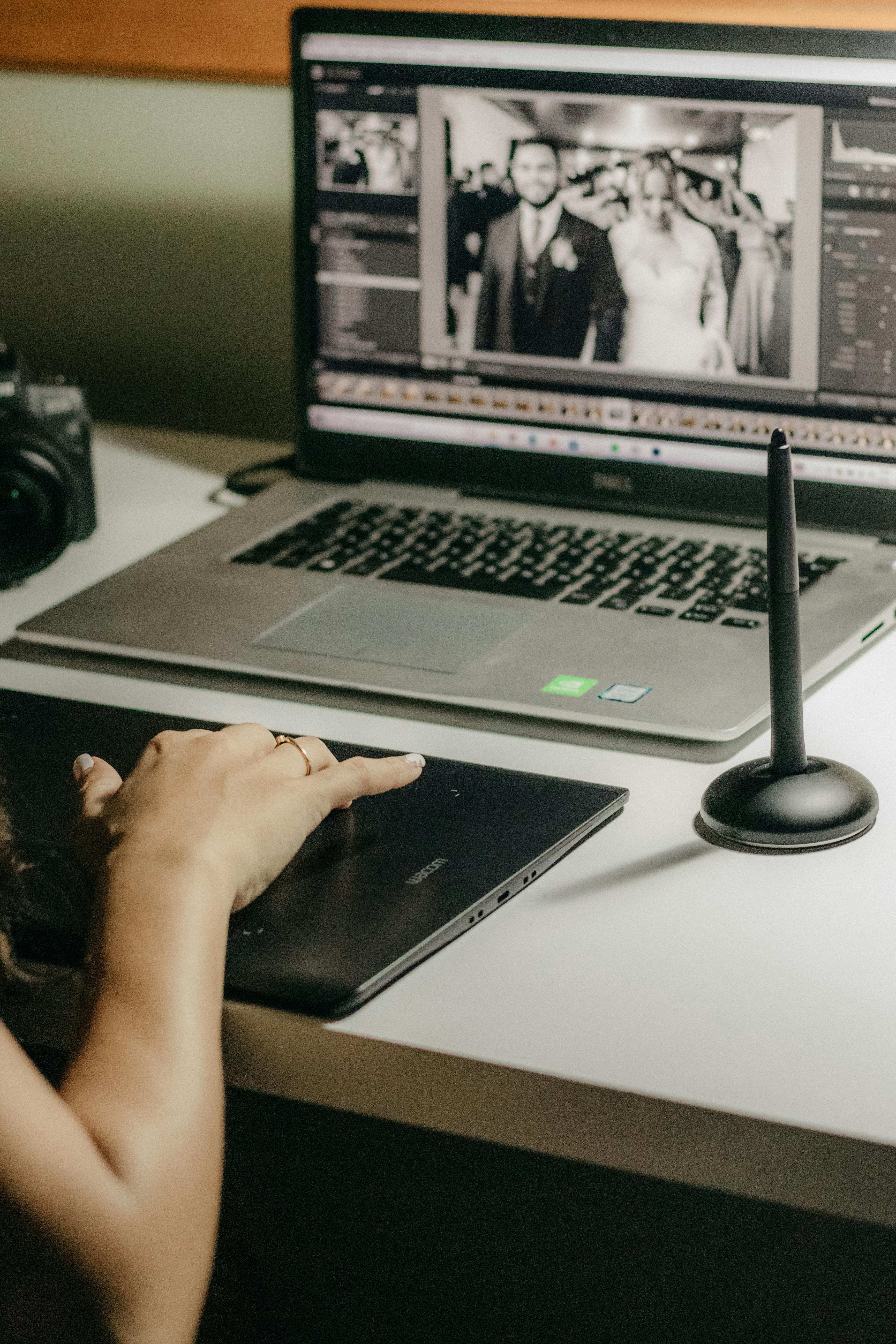A woman is using a laptop to take photos · Free Stock Photo