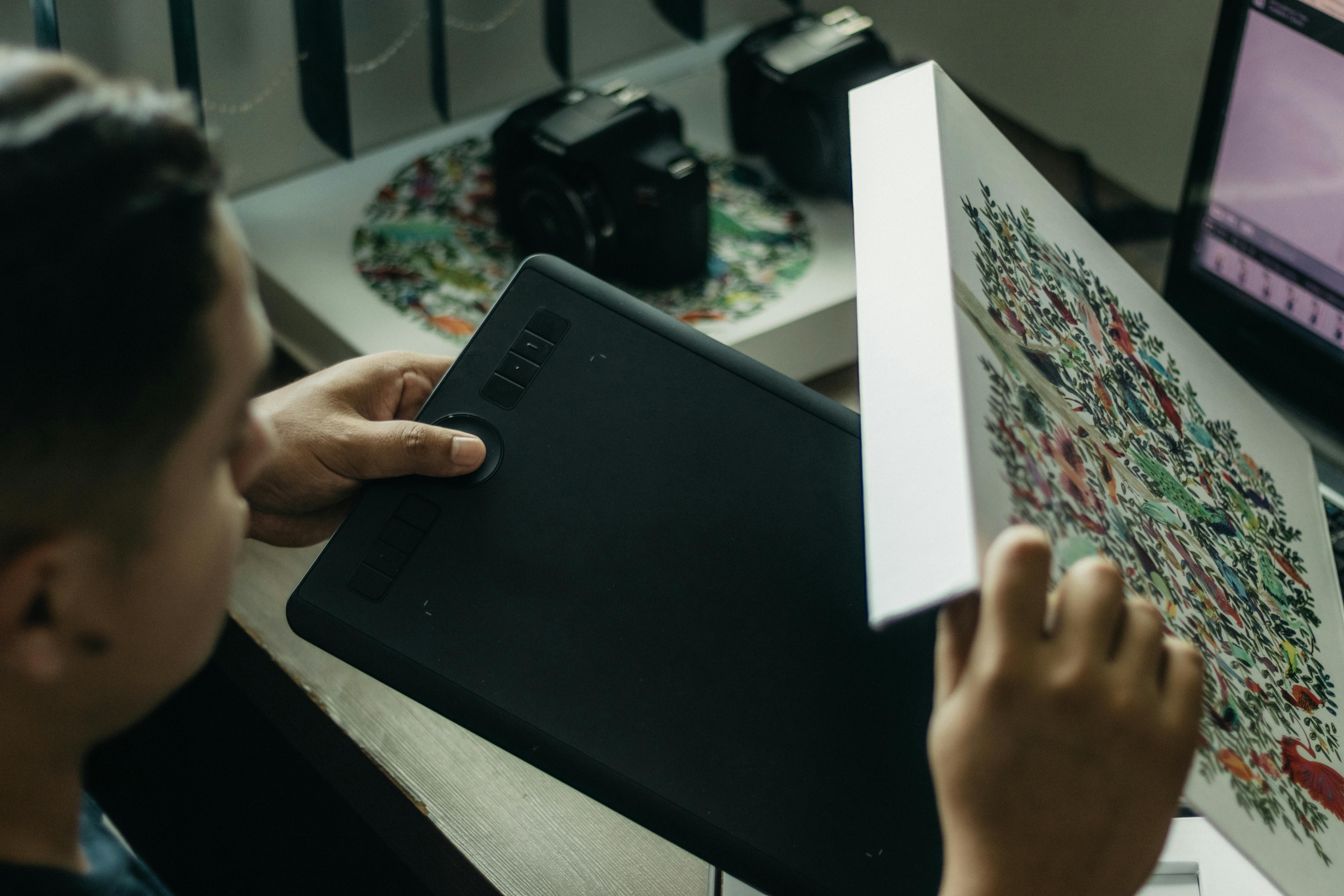 Man Putting Wacom Intuos Pro M into Box · Free Stock Photo