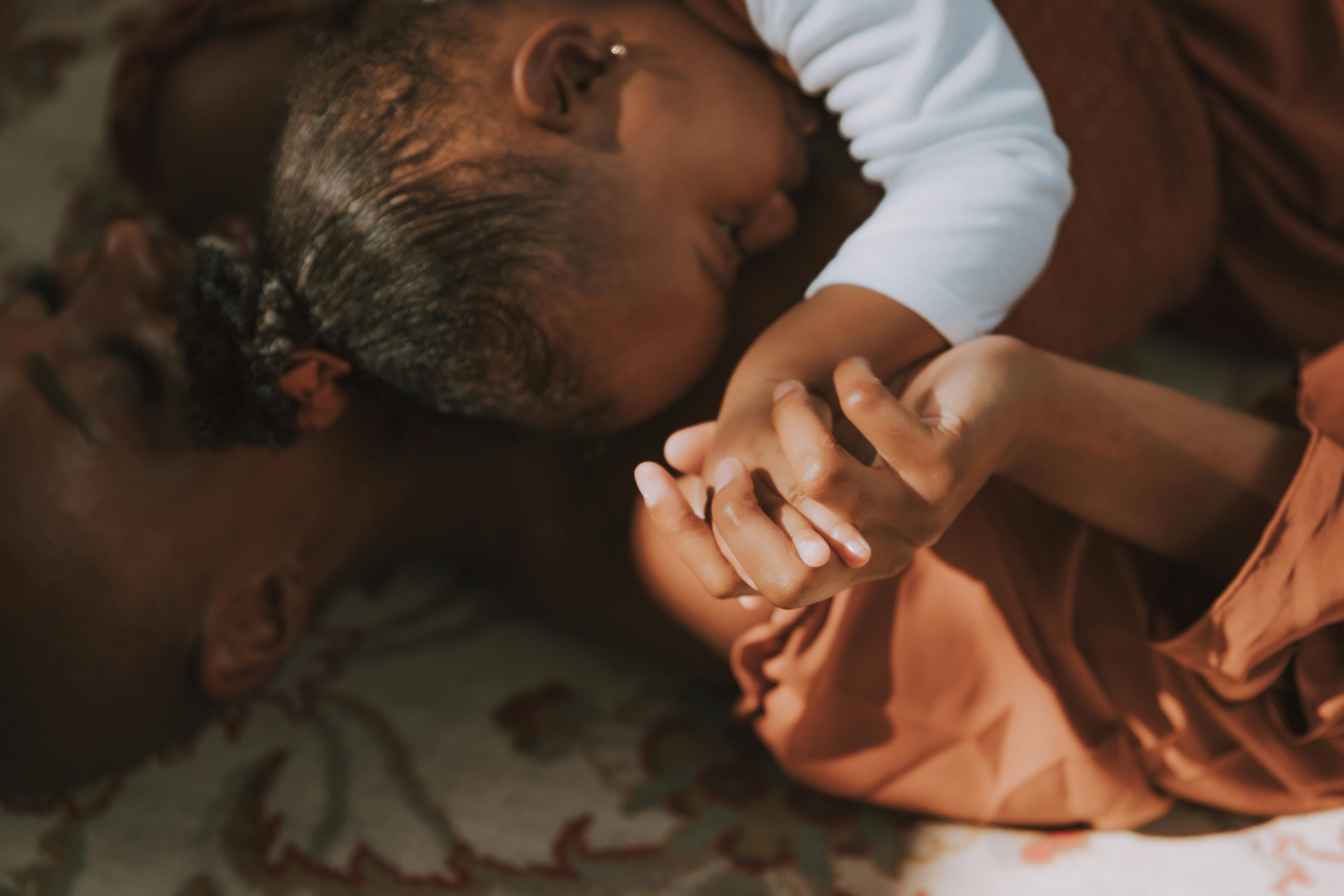 Woman Holding Her Baby during Baptism · Free Stock Photo