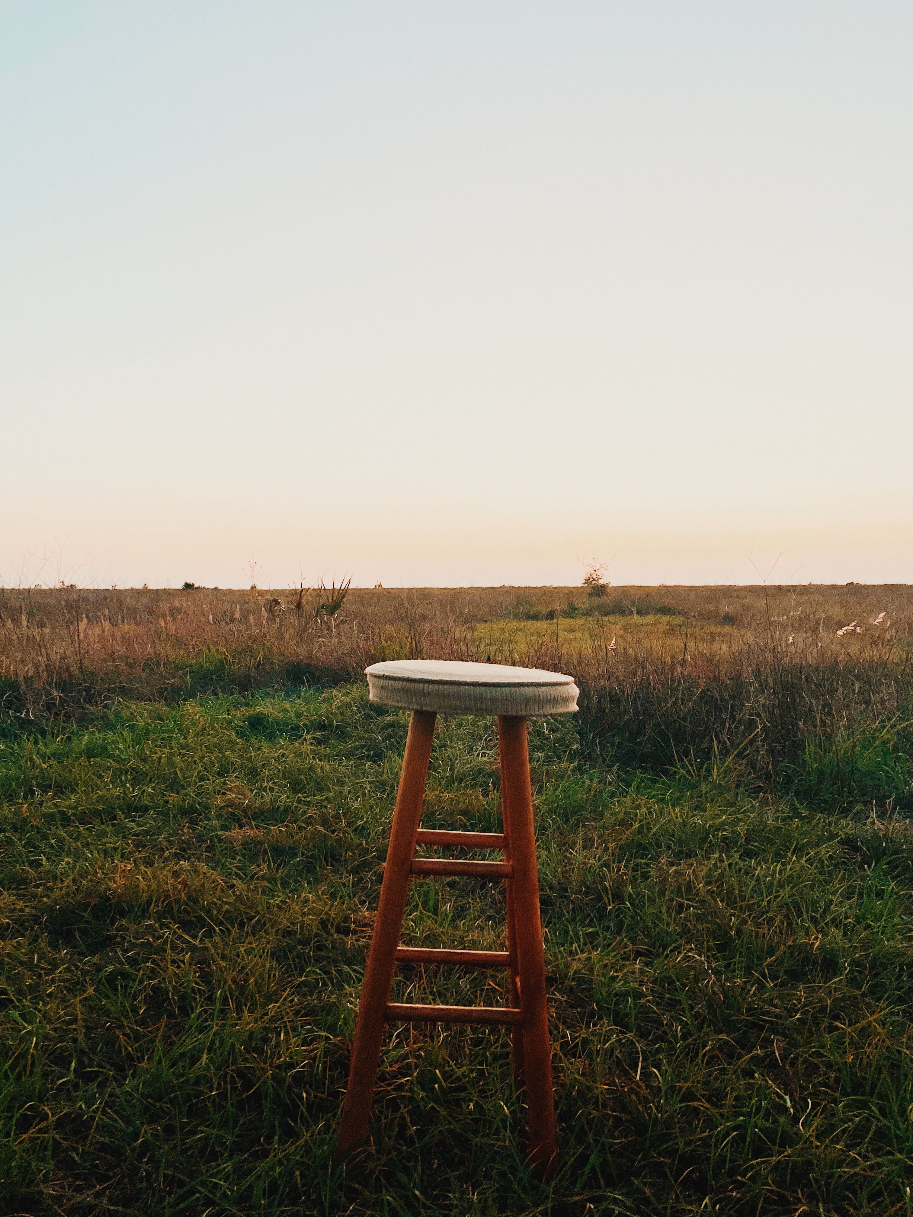 Bar Stool Standing on Grass Field · Free Stock Photo