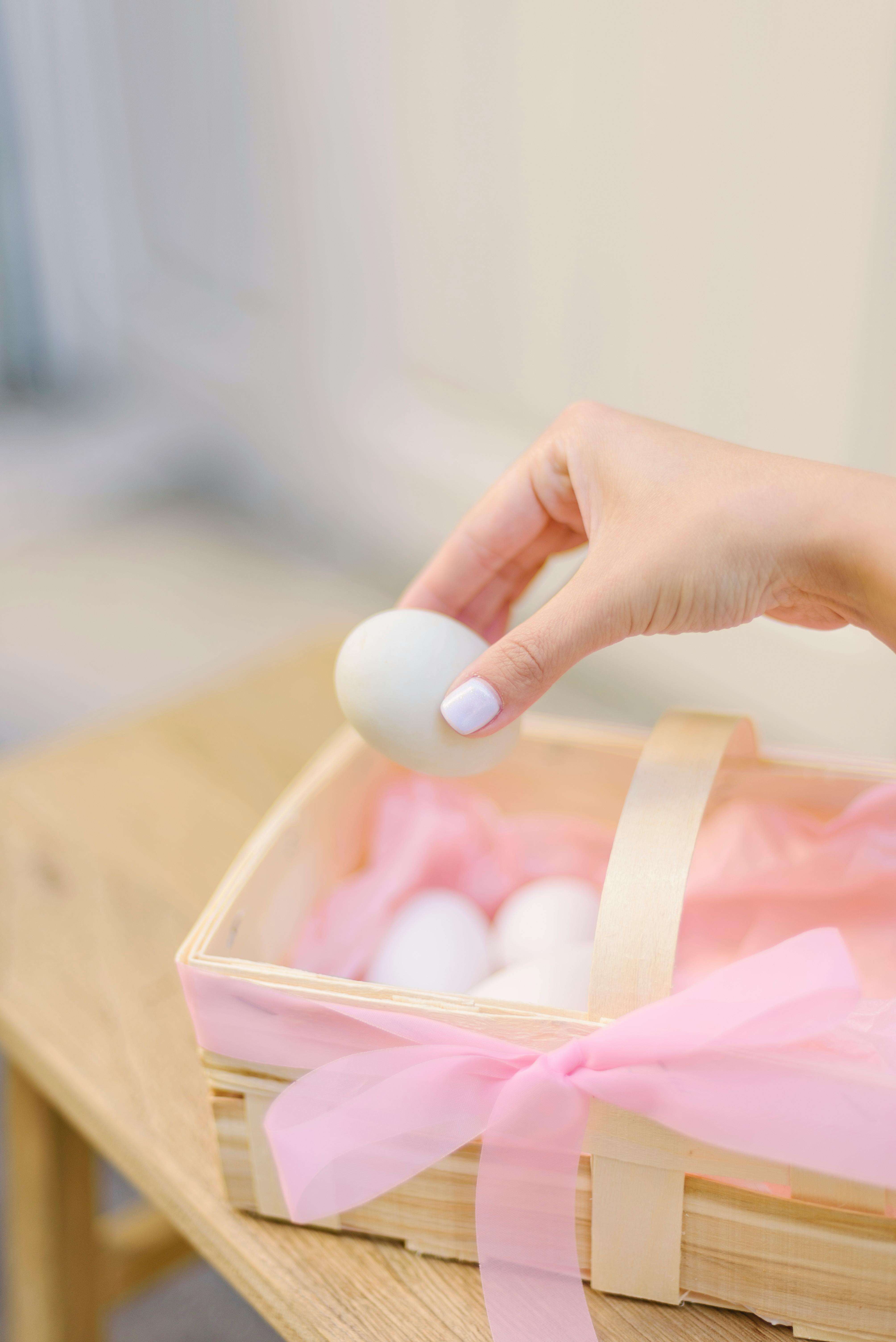 Woman Putting an Egg in the Basket · Free Stock Photo