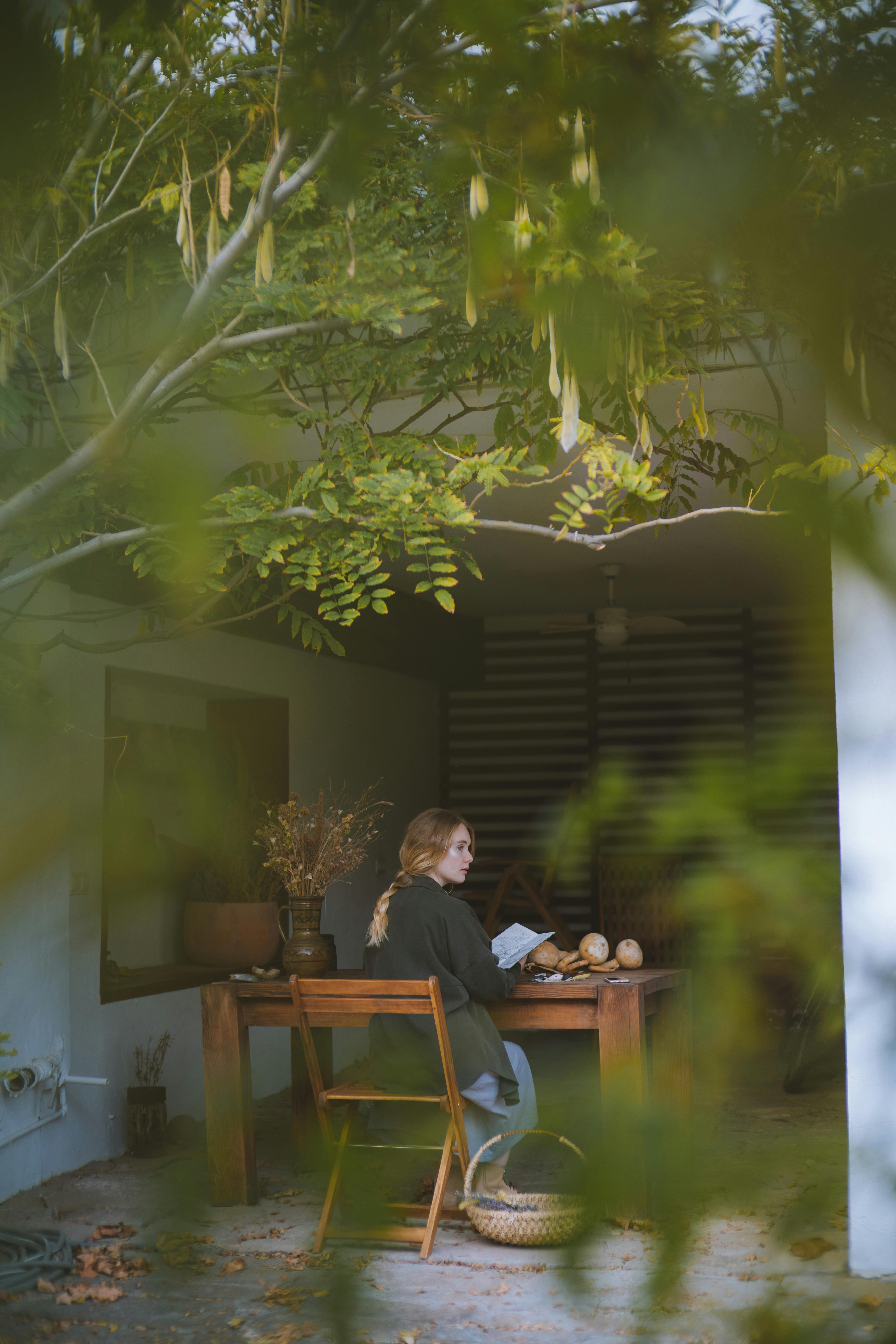Man Sitting Beside Table Near Plastic Cups · Free Stock Photo