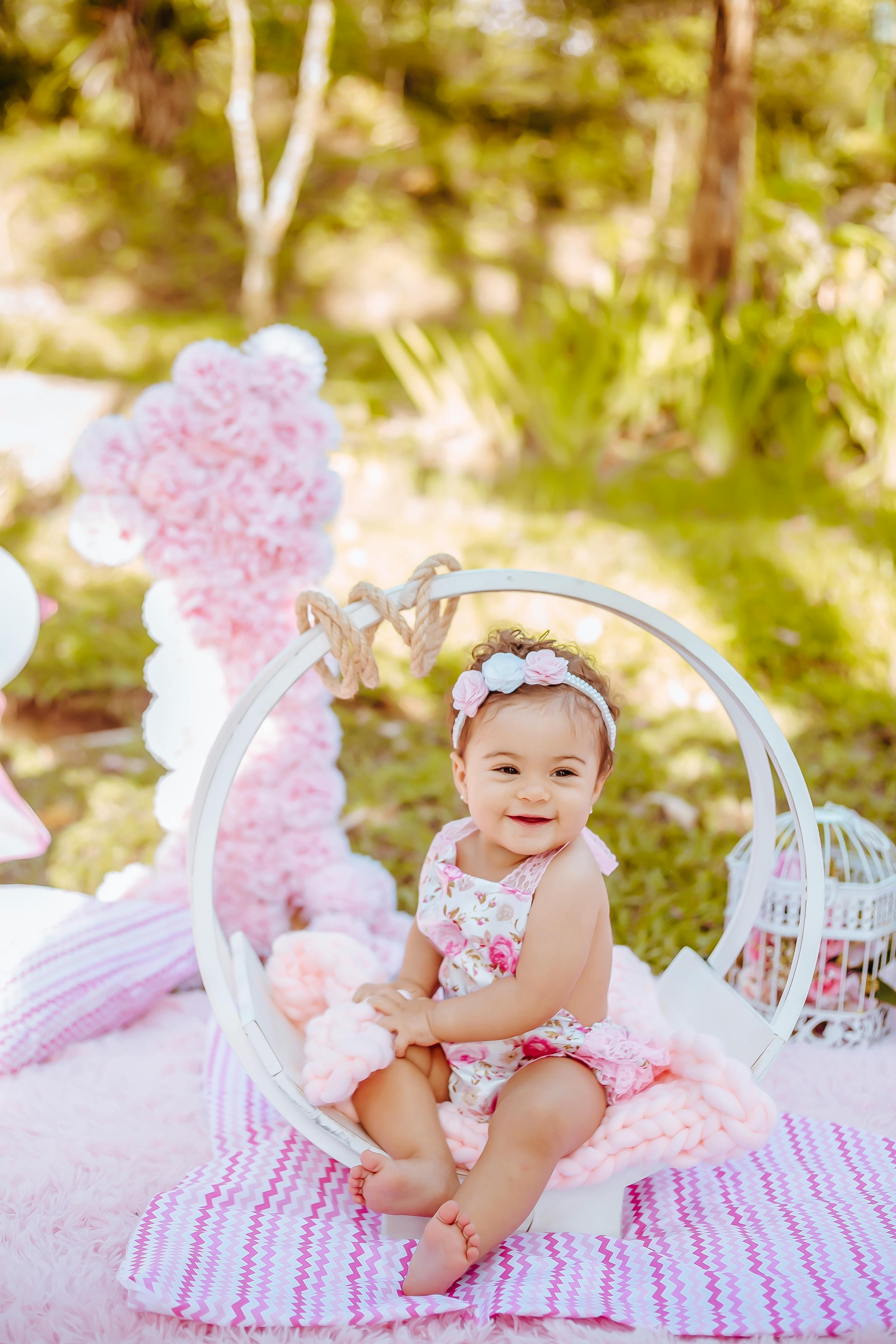 Photo of a Cheerful Baby in a Garden · Free Stock Photo
