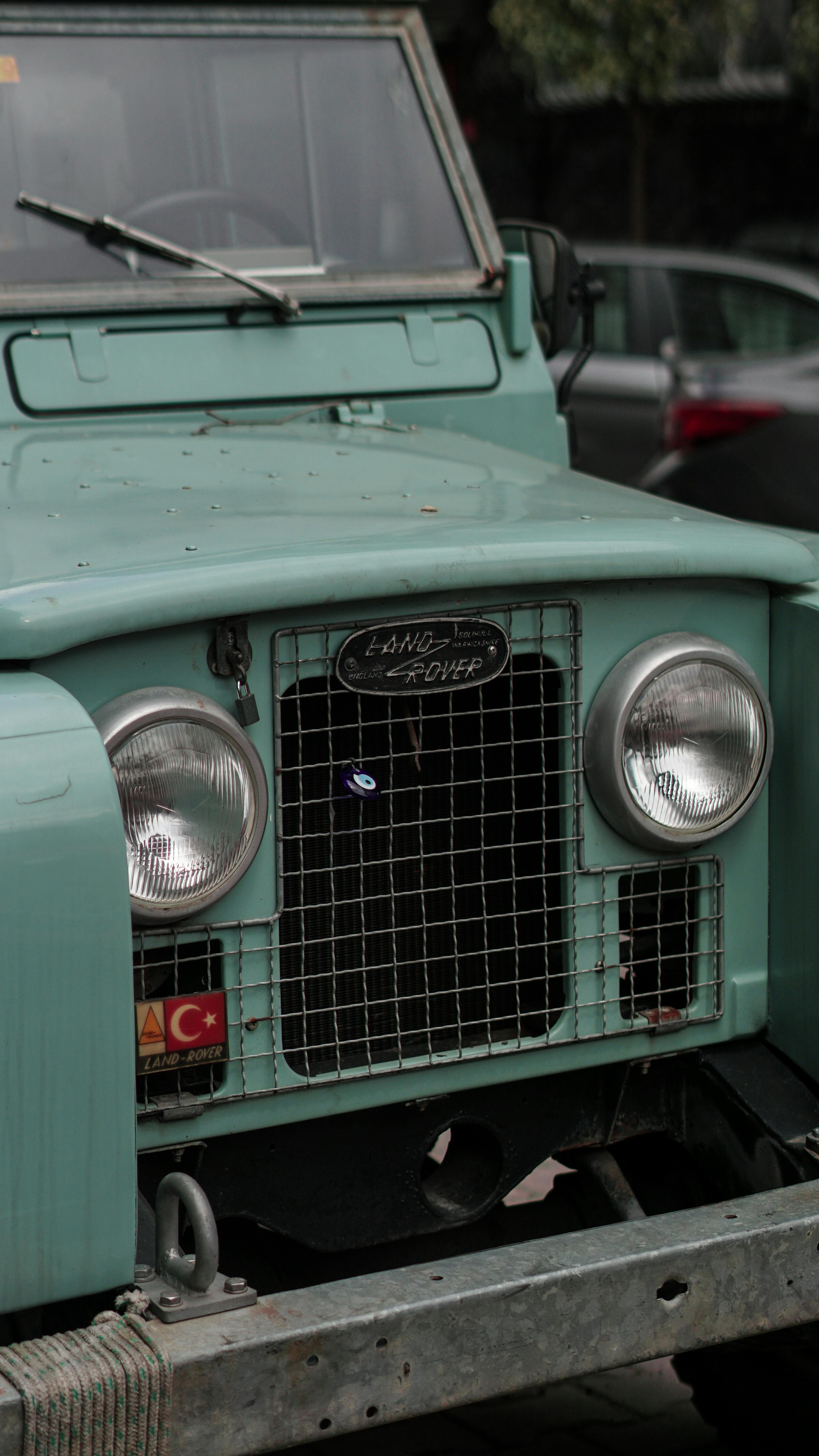 Man Stands Near White Land Rover Defender at Daytime · Free Stock Photo