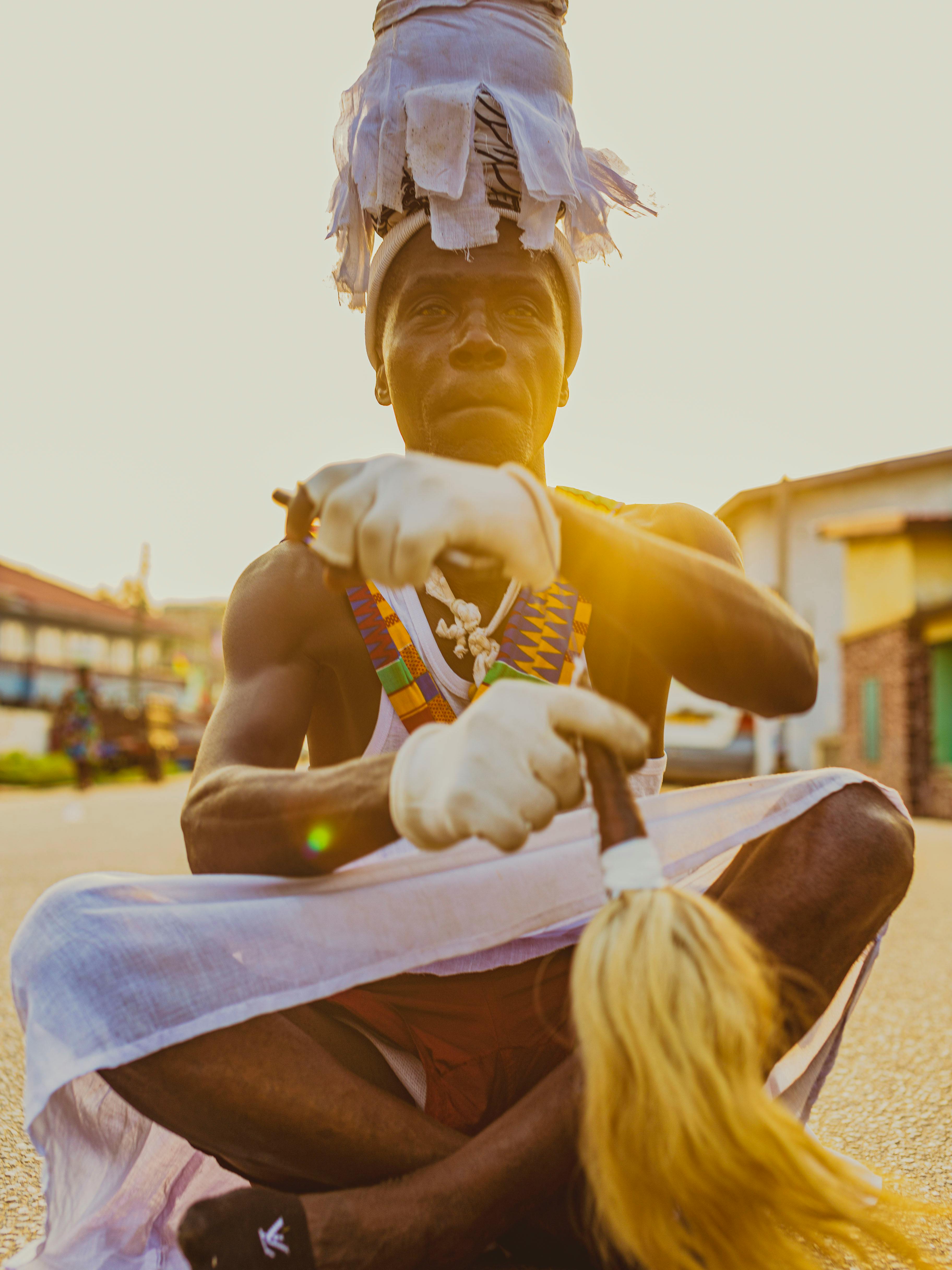 Witch Doctor Sitting in Traditional Clothing · Free Stock Photo