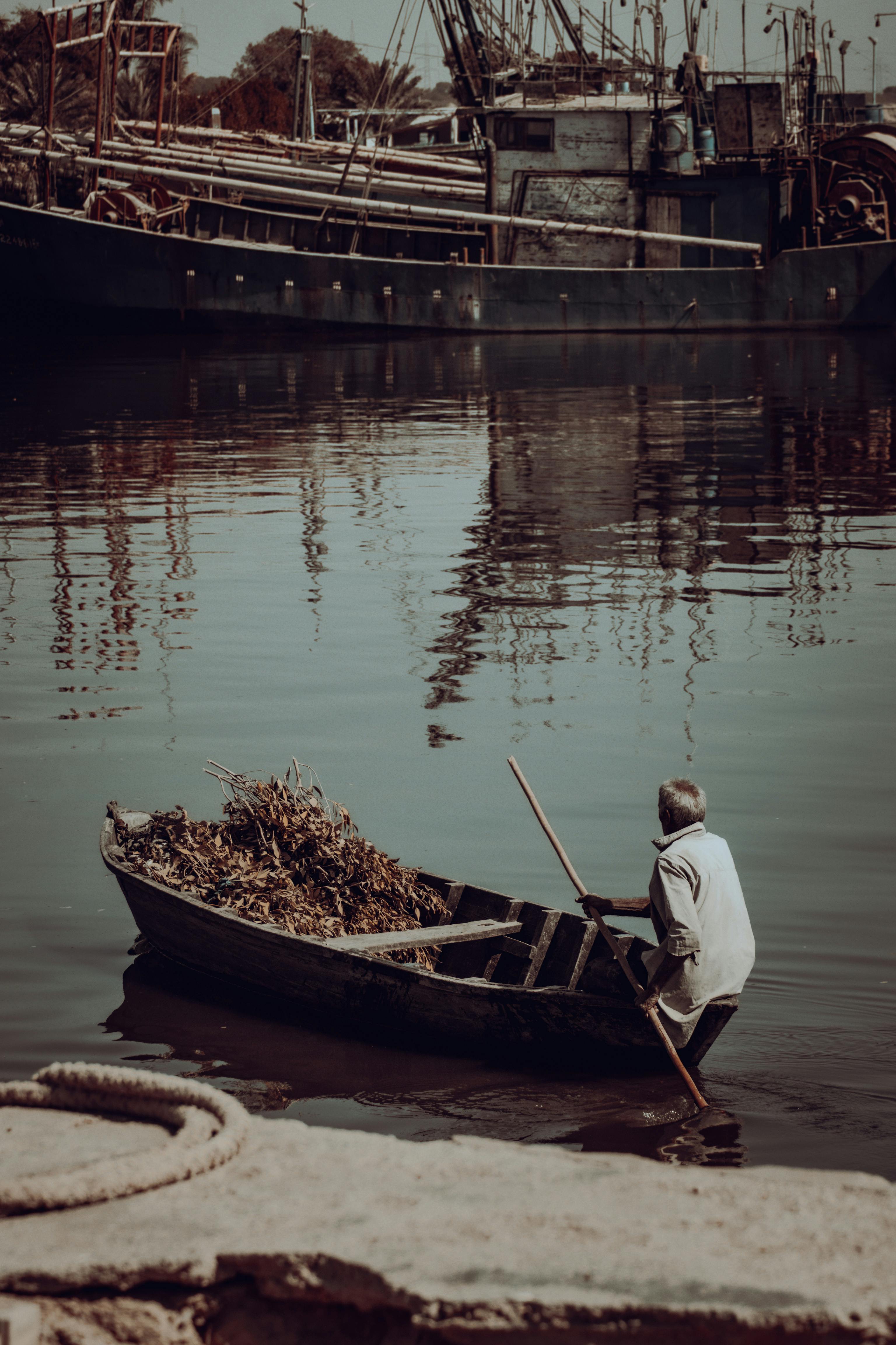 A Fisherman Swimming on a Boat · Free Stock Photo