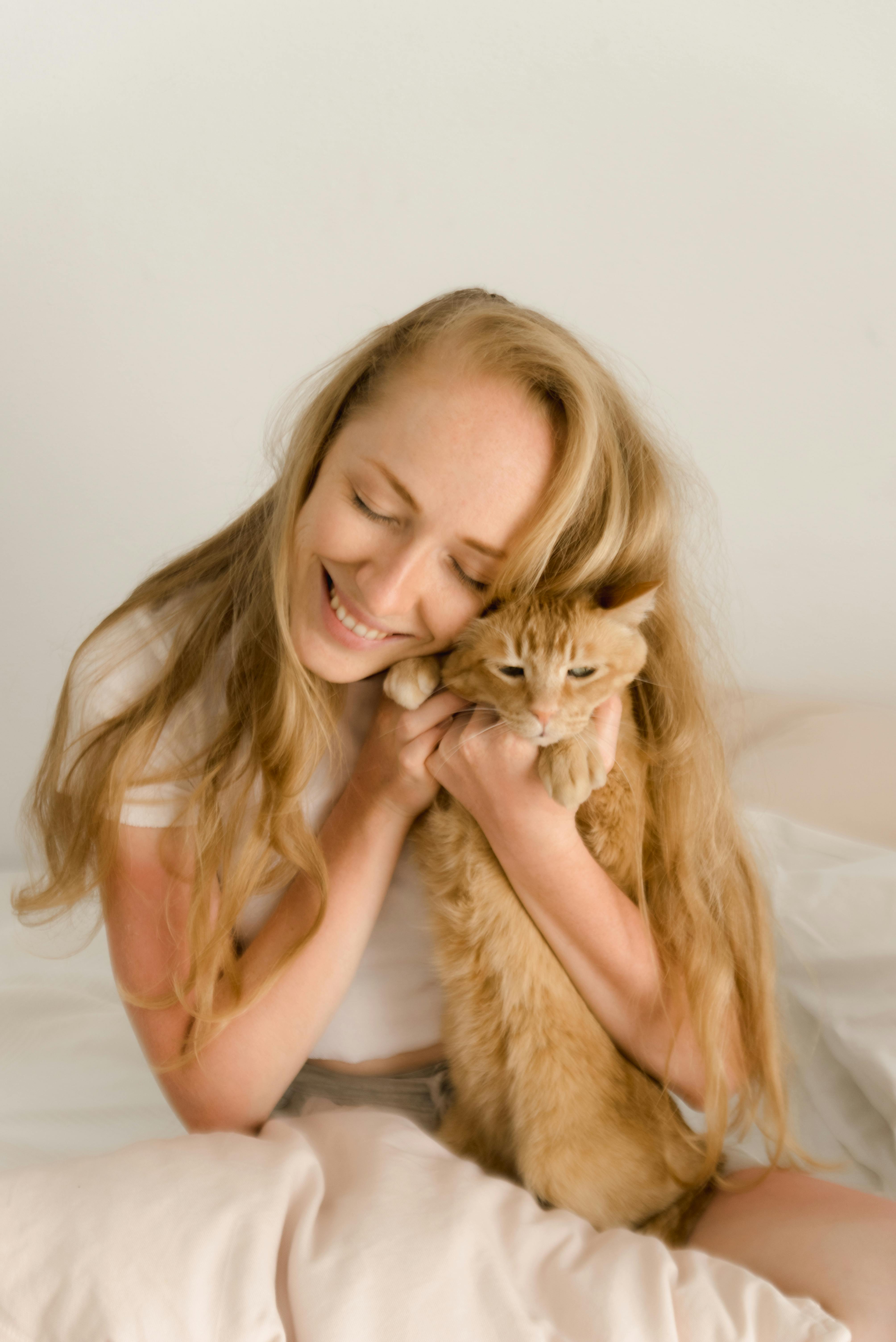 Woman Hugging Ginger Cat · Free Stock Photo