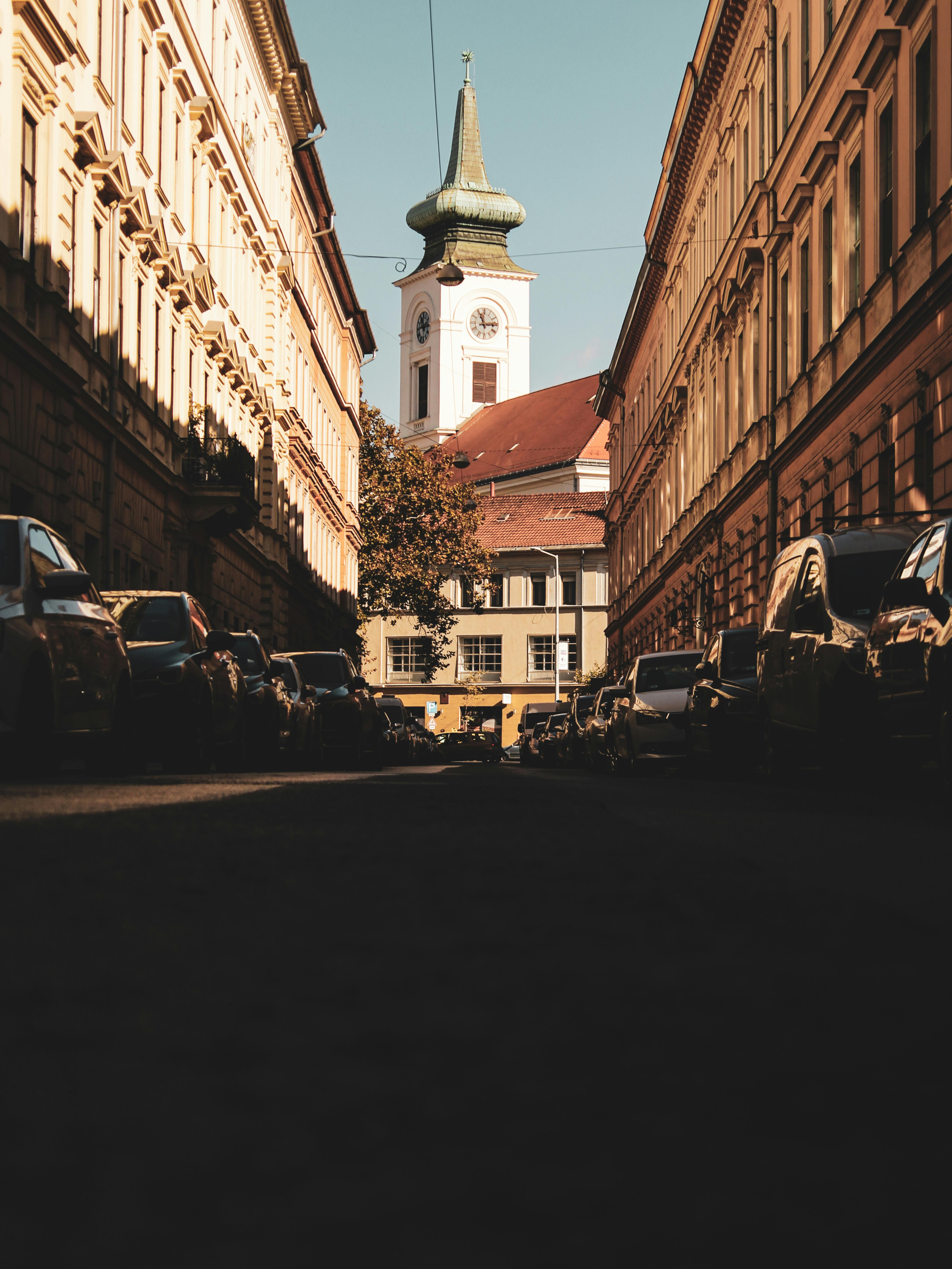 A Clock Tower of Church at the End of a Street in Budapest · Free Stock ...
