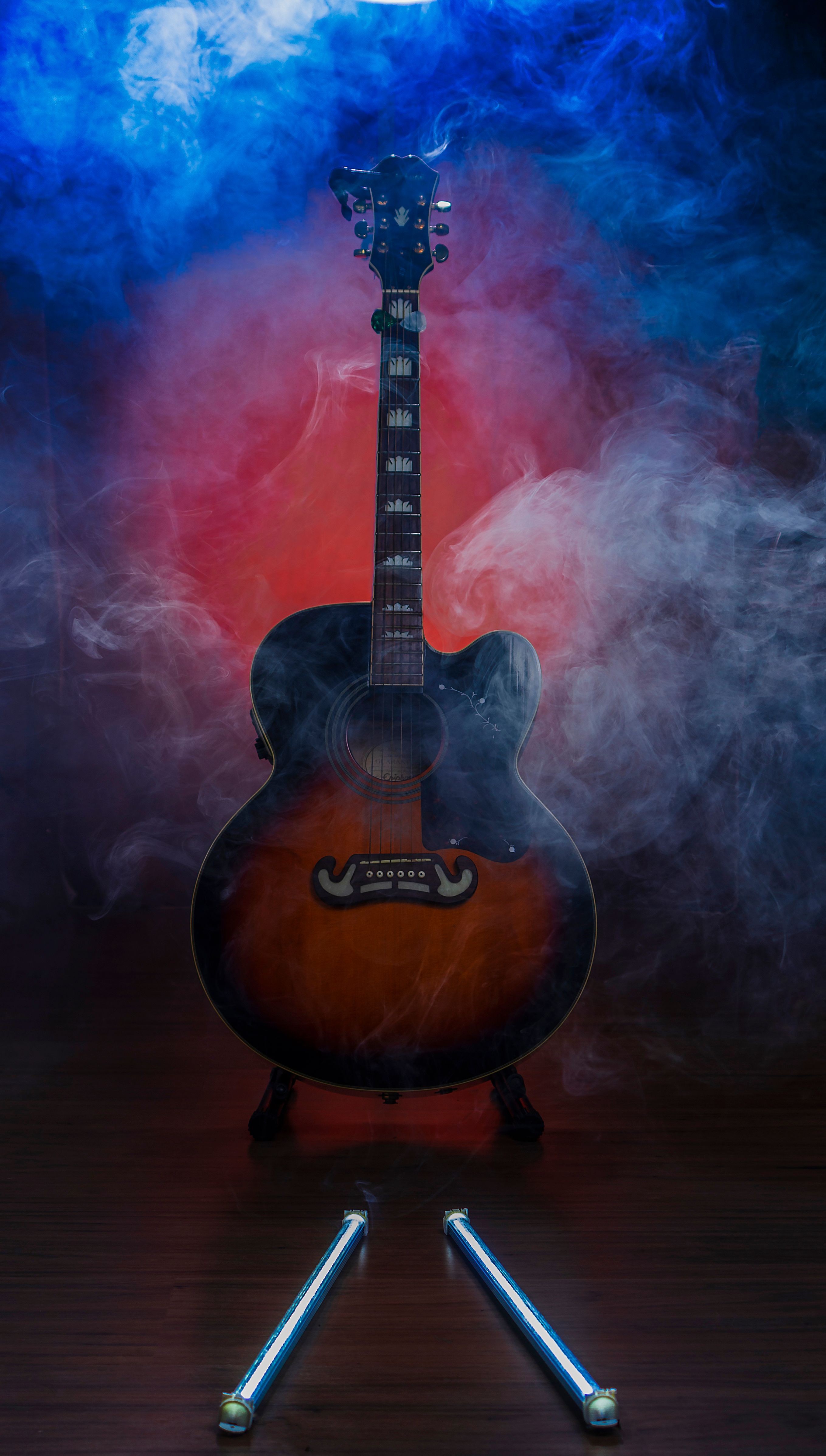 Photo of a Guitar on a Stand Surrounded by Smoke · Free Stock Photo