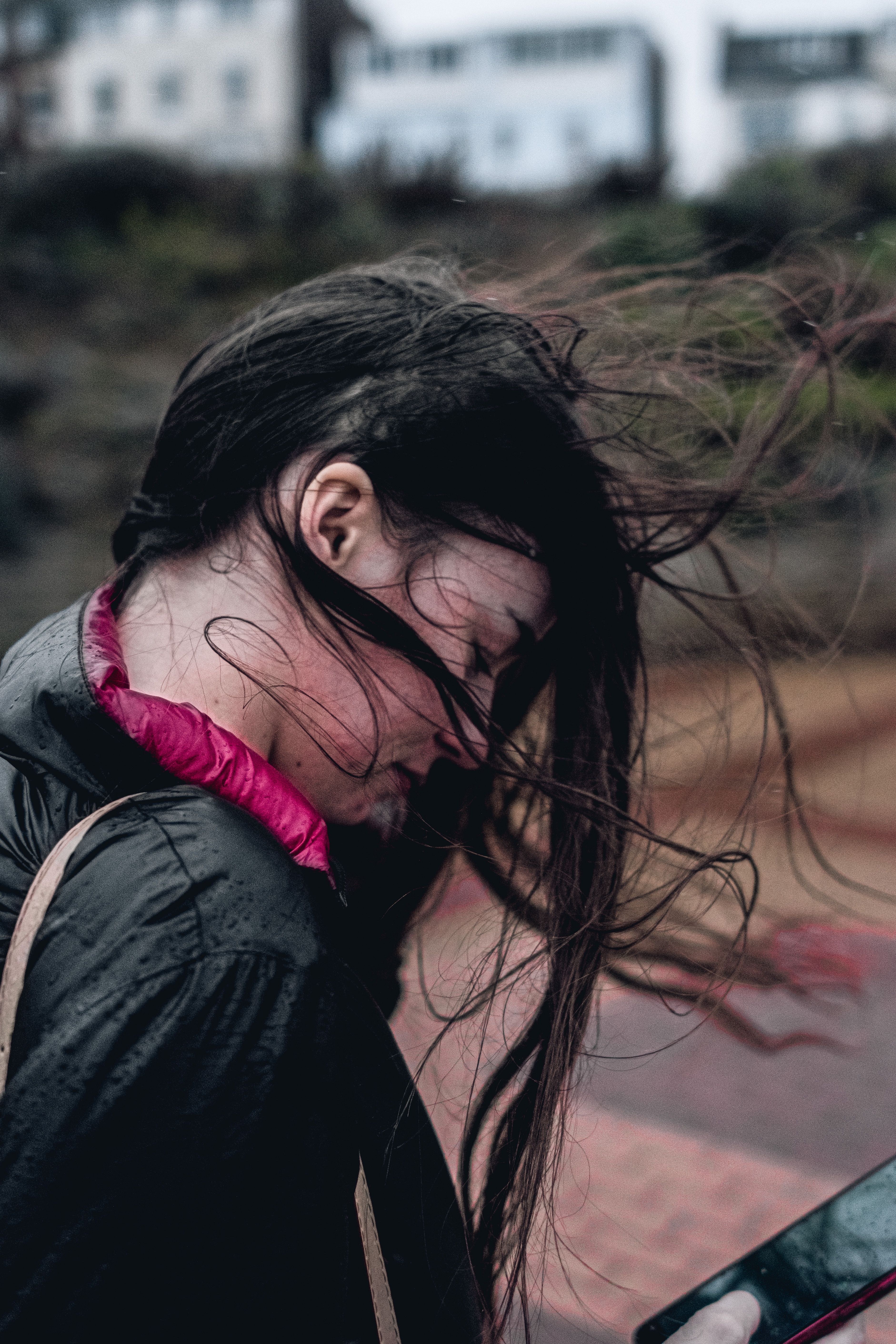 Young Woman with Messy Hair Walking Outdoors in Rain and Wind · Free ...