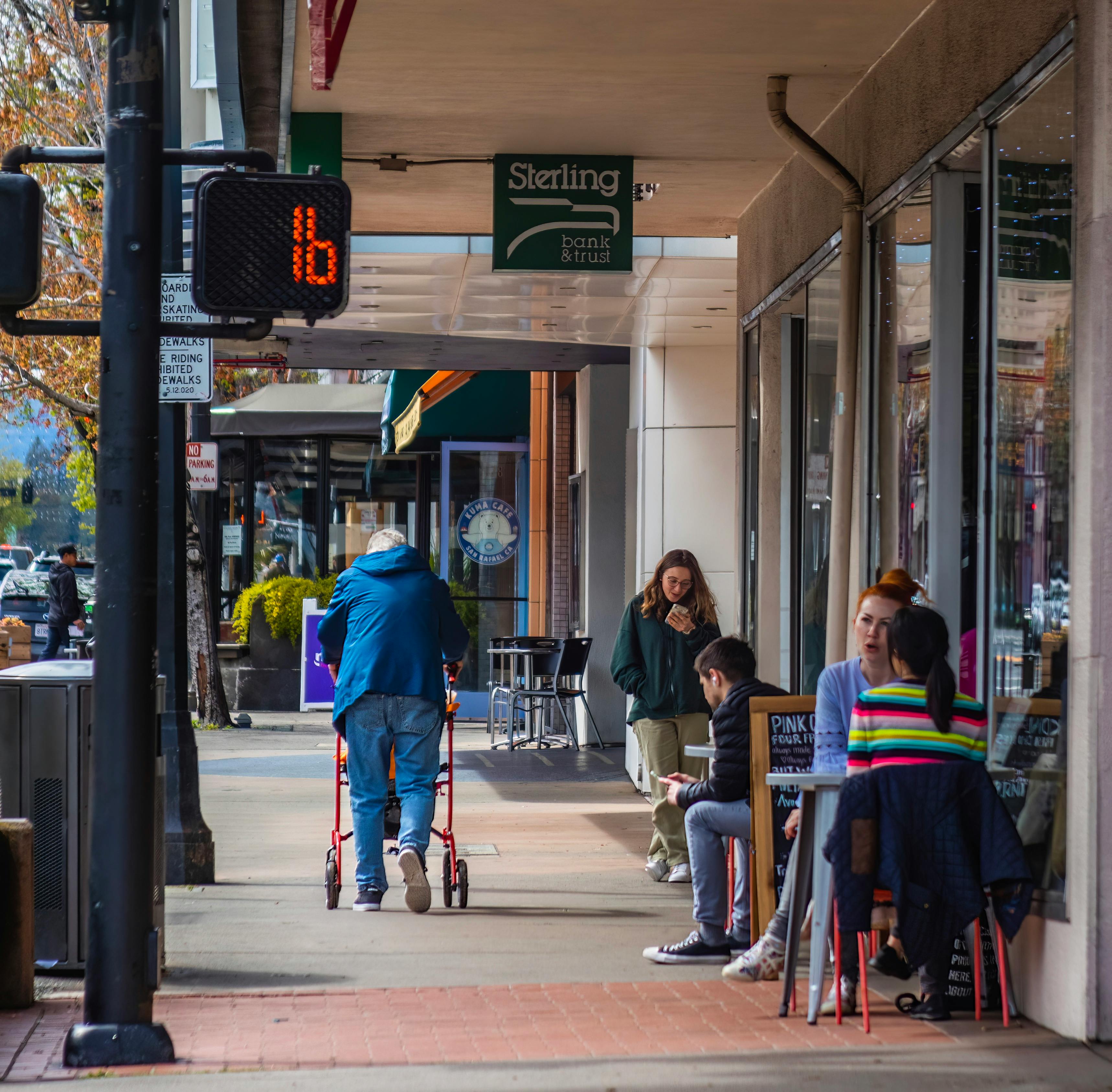 People Sitting Outside a Cafe on a Sidewalk · Free Stock Photo