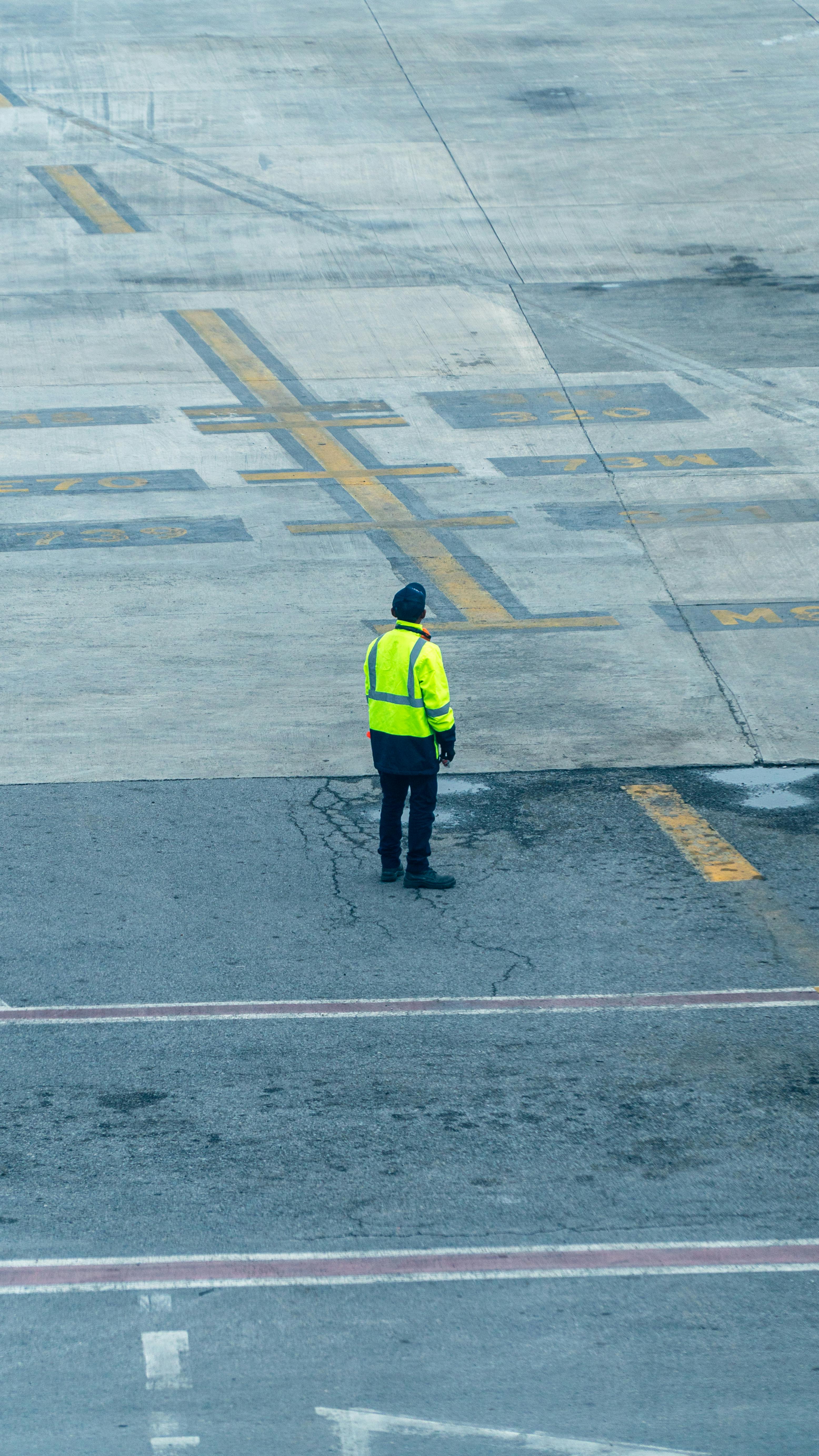 Ground Crew Member on Tarmac · Free Stock Photo