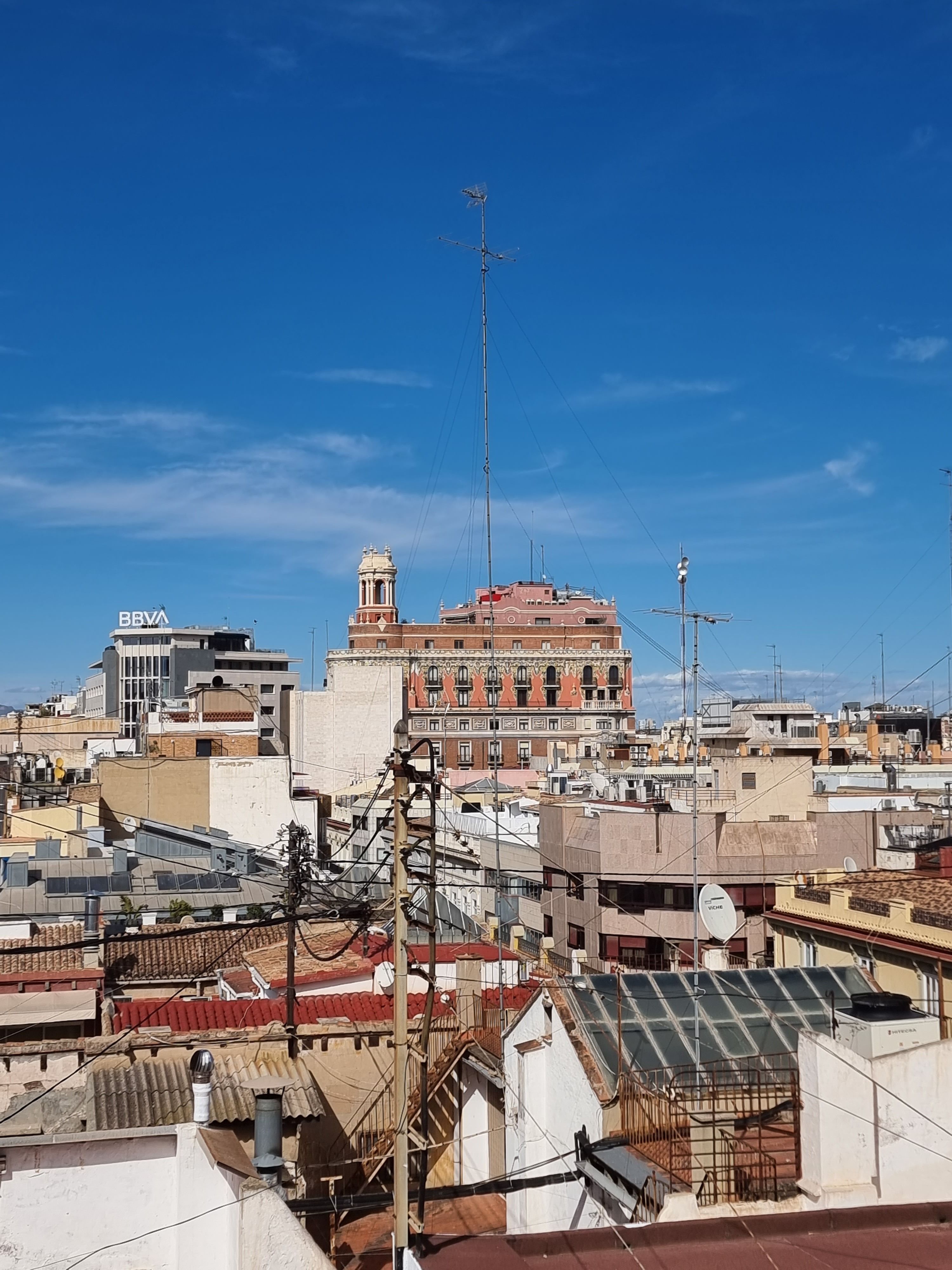Clear Sky over Sunlit Buildings in Town · Free Stock Photo