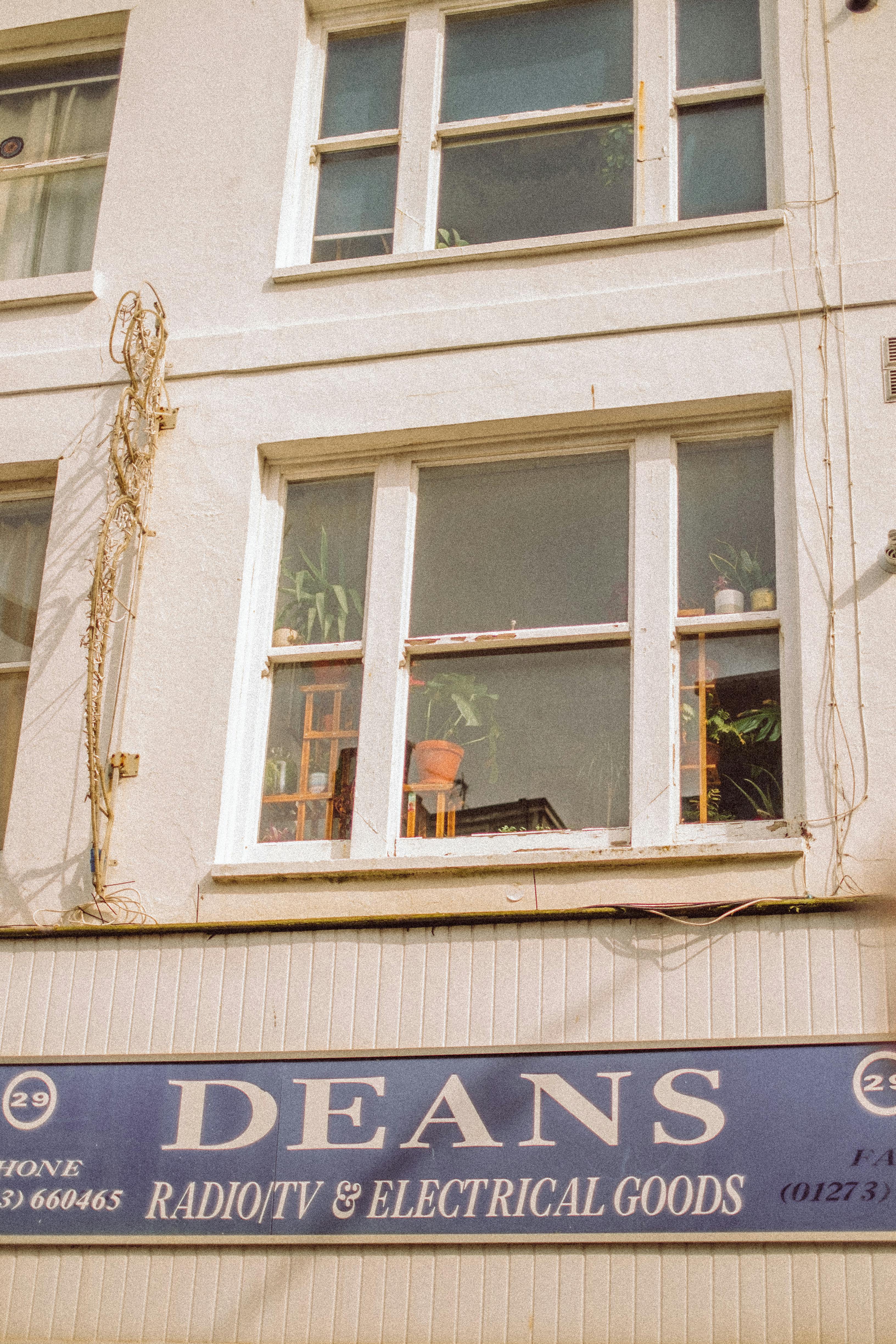 A sign for deans electricals on the side of a building · Free Stock Photo