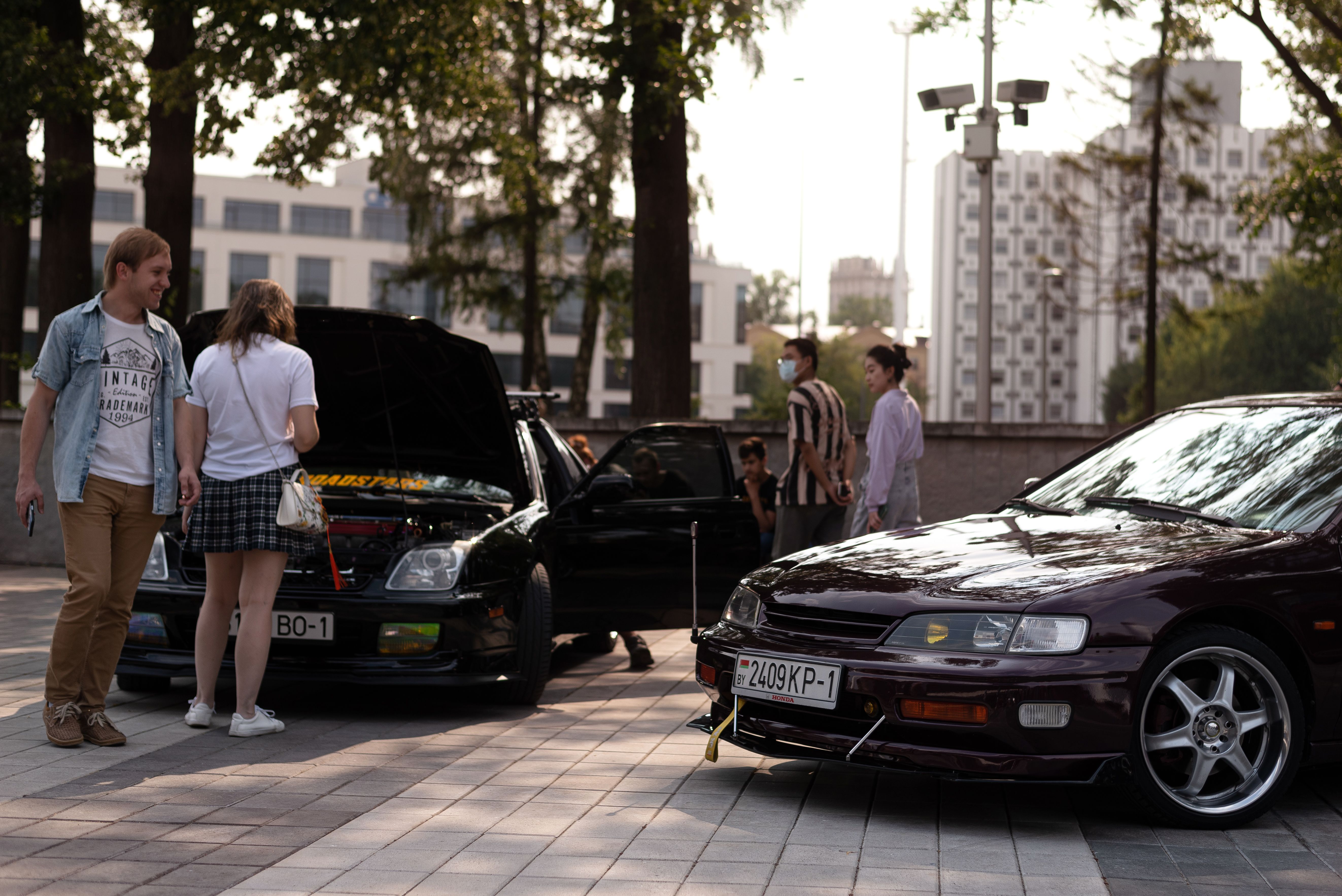 People Standing near Cars on Pavement · Free Stock Photo