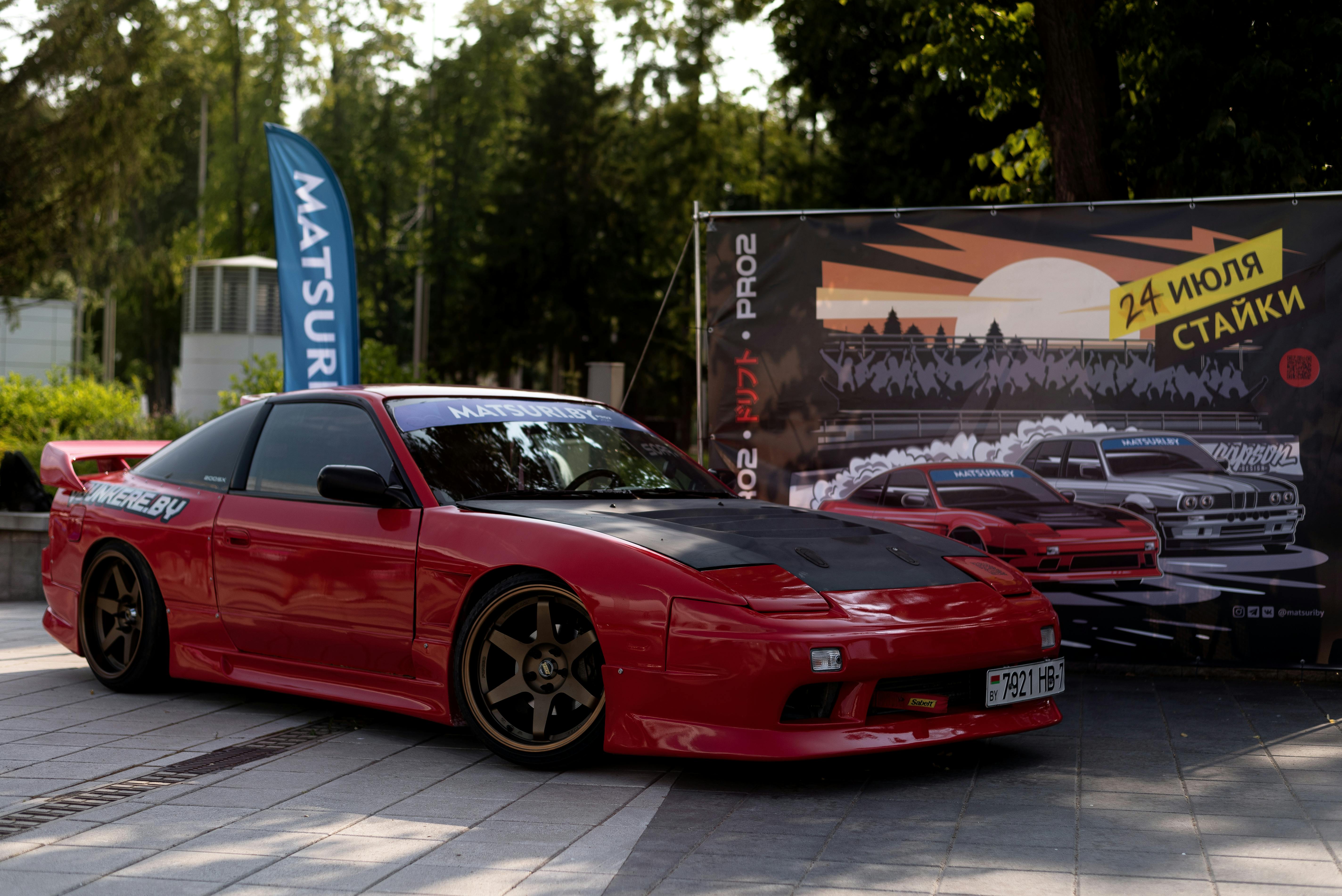 Red Racecar Parked at a Garage · Free Stock Photo