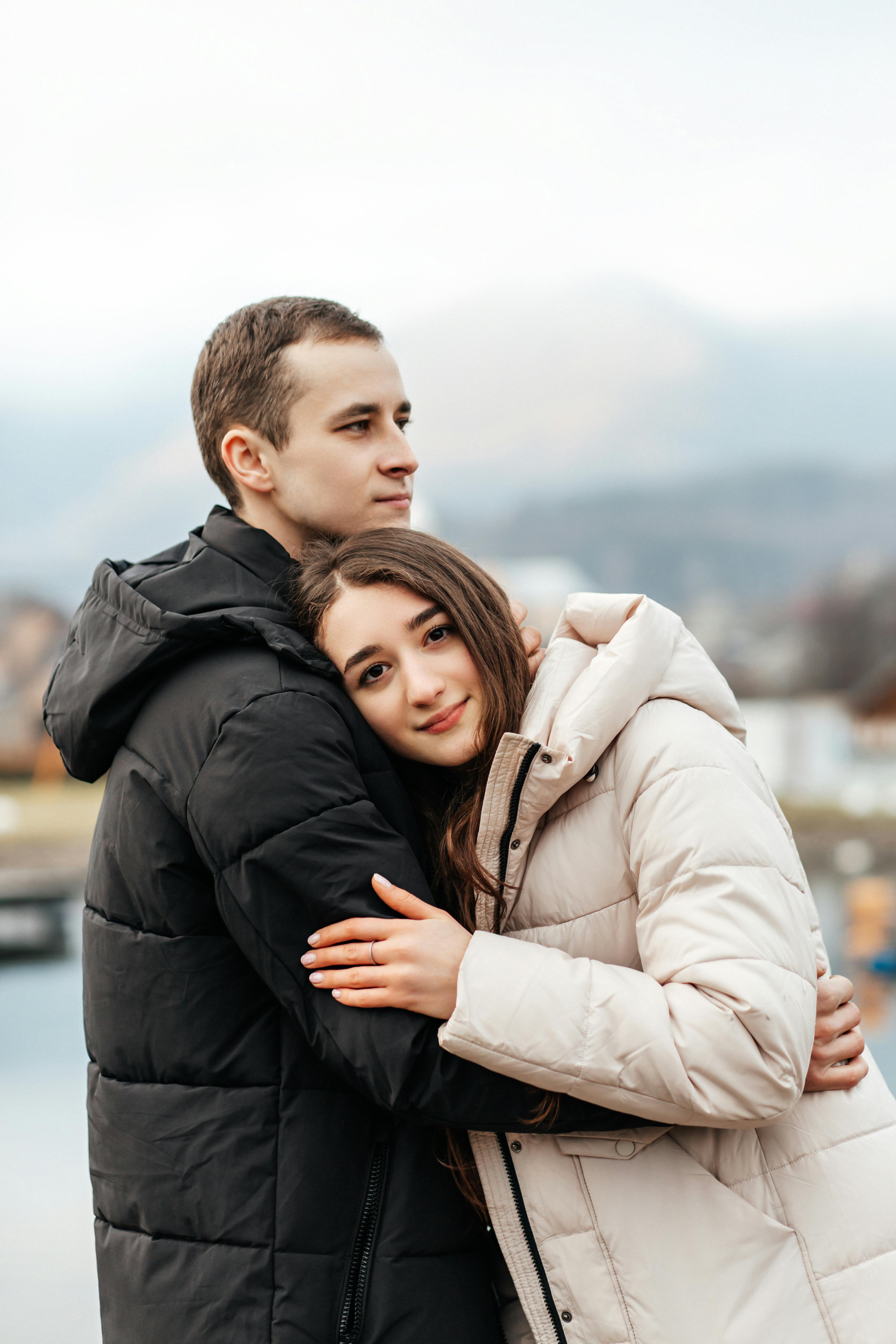 Photo of an Embracing Couple Wearing Jackets · Free Stock Photo