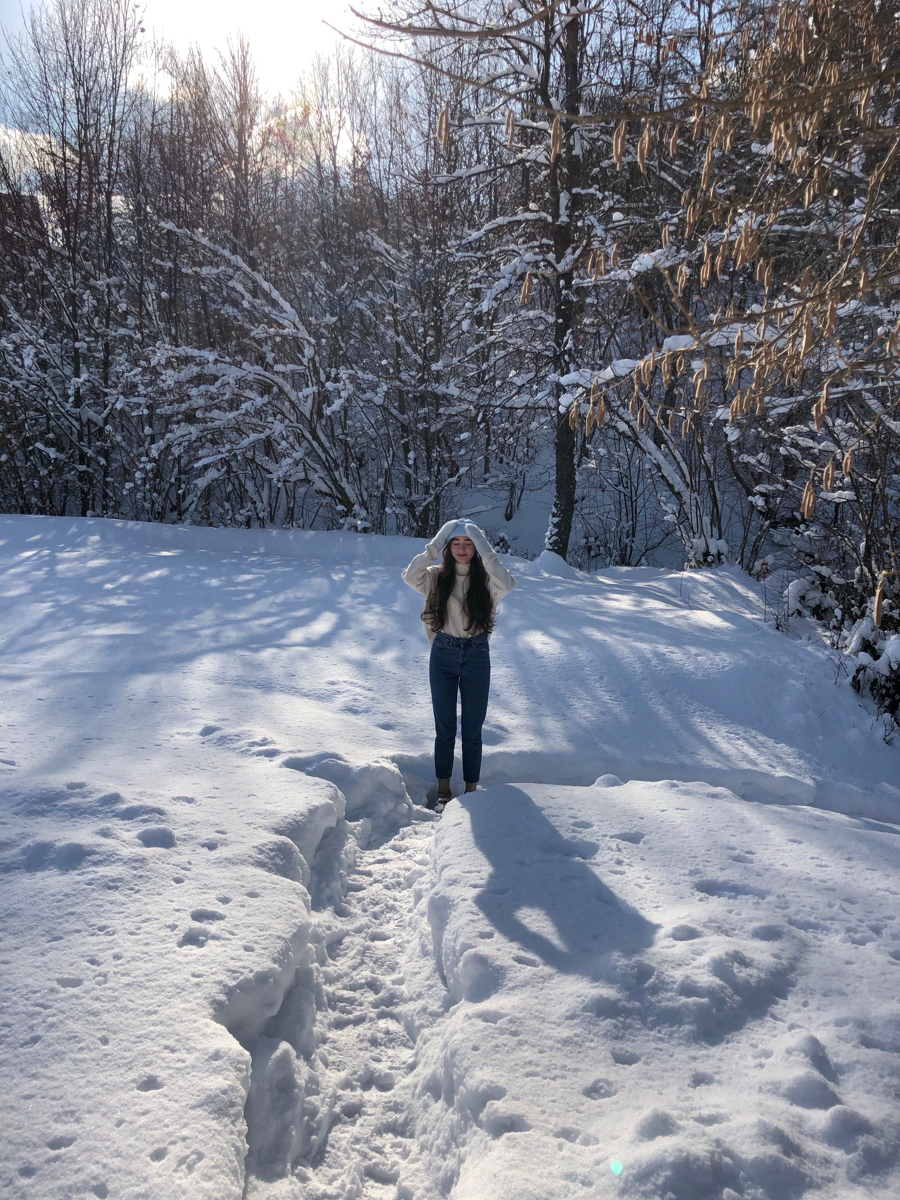 A Woman Standing on a Snowy Field · Free Stock Photo