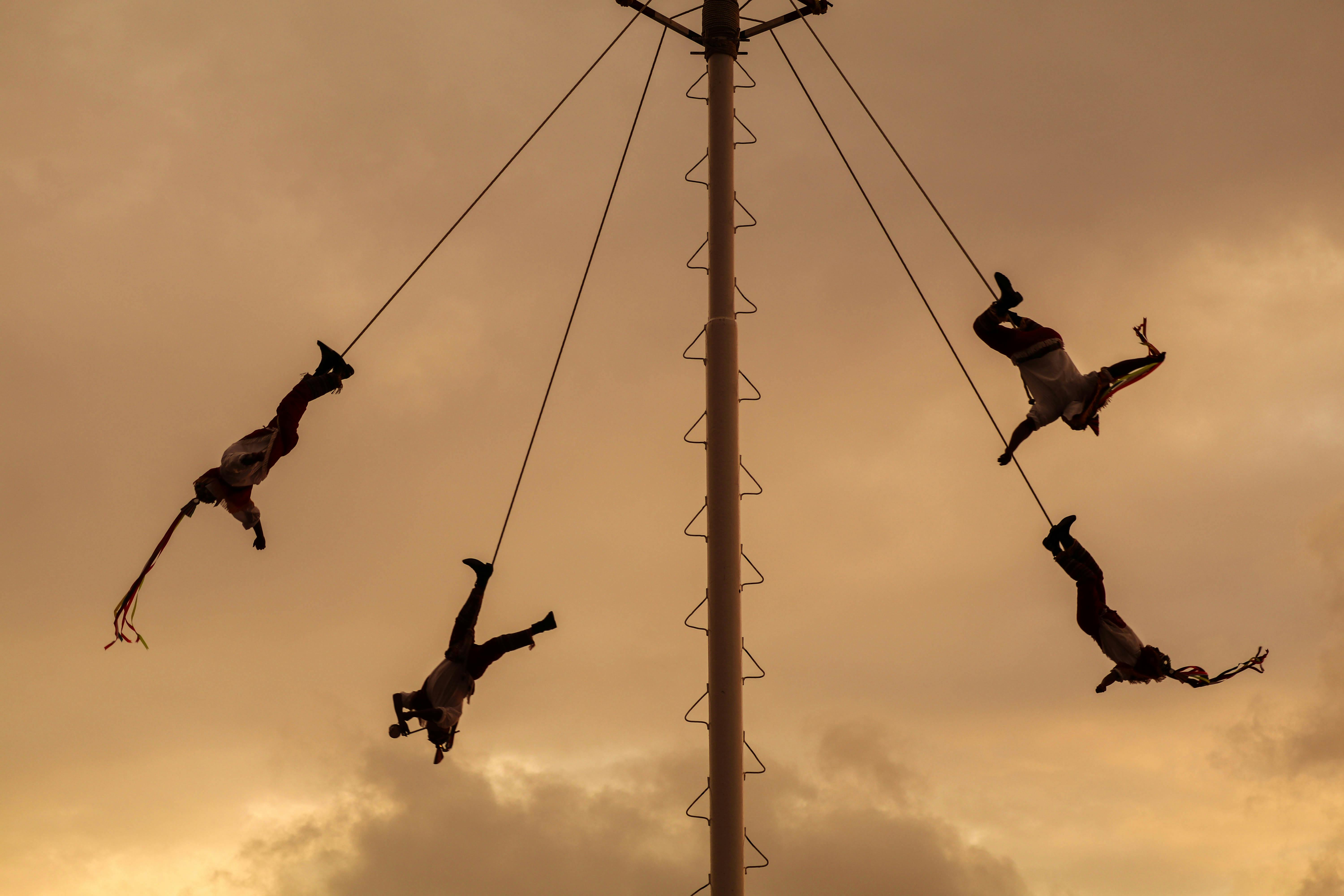 Acrobats Hanging on Pole · Free Stock Photo