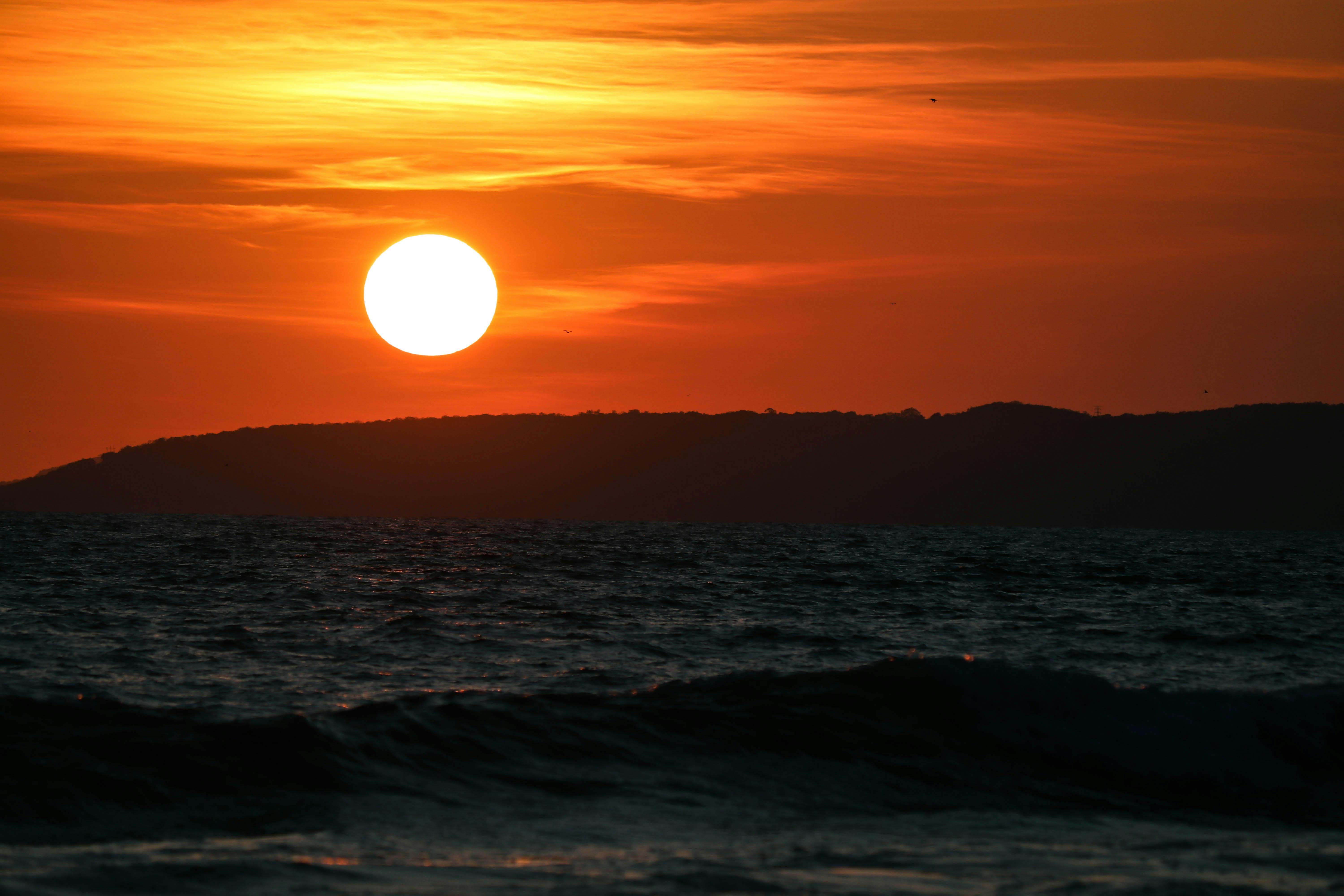 Sun over Sea Shore at Sunset · Free Stock Photo
