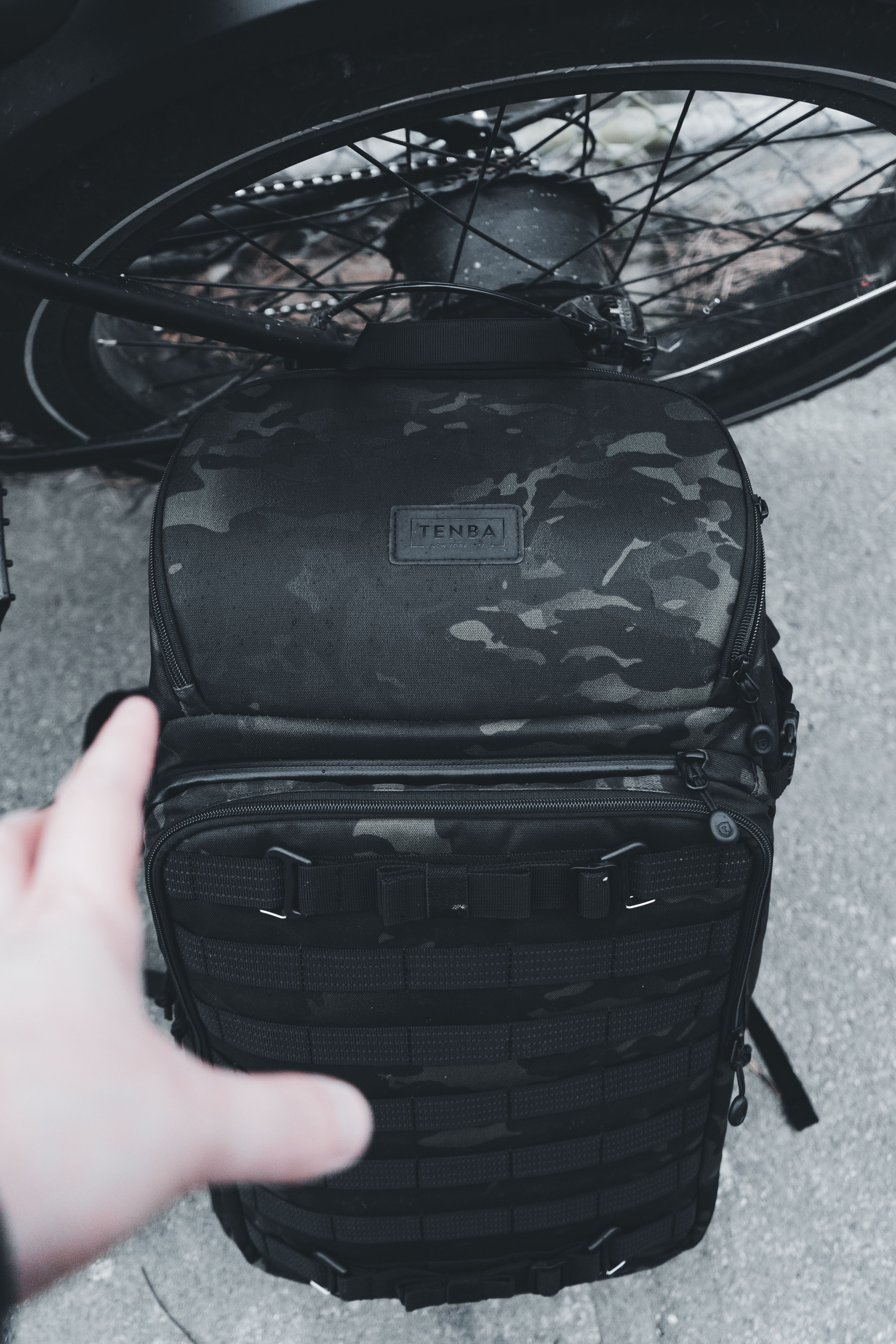 Person Reaching Hand Toward the Backpack · Free Stock Photo