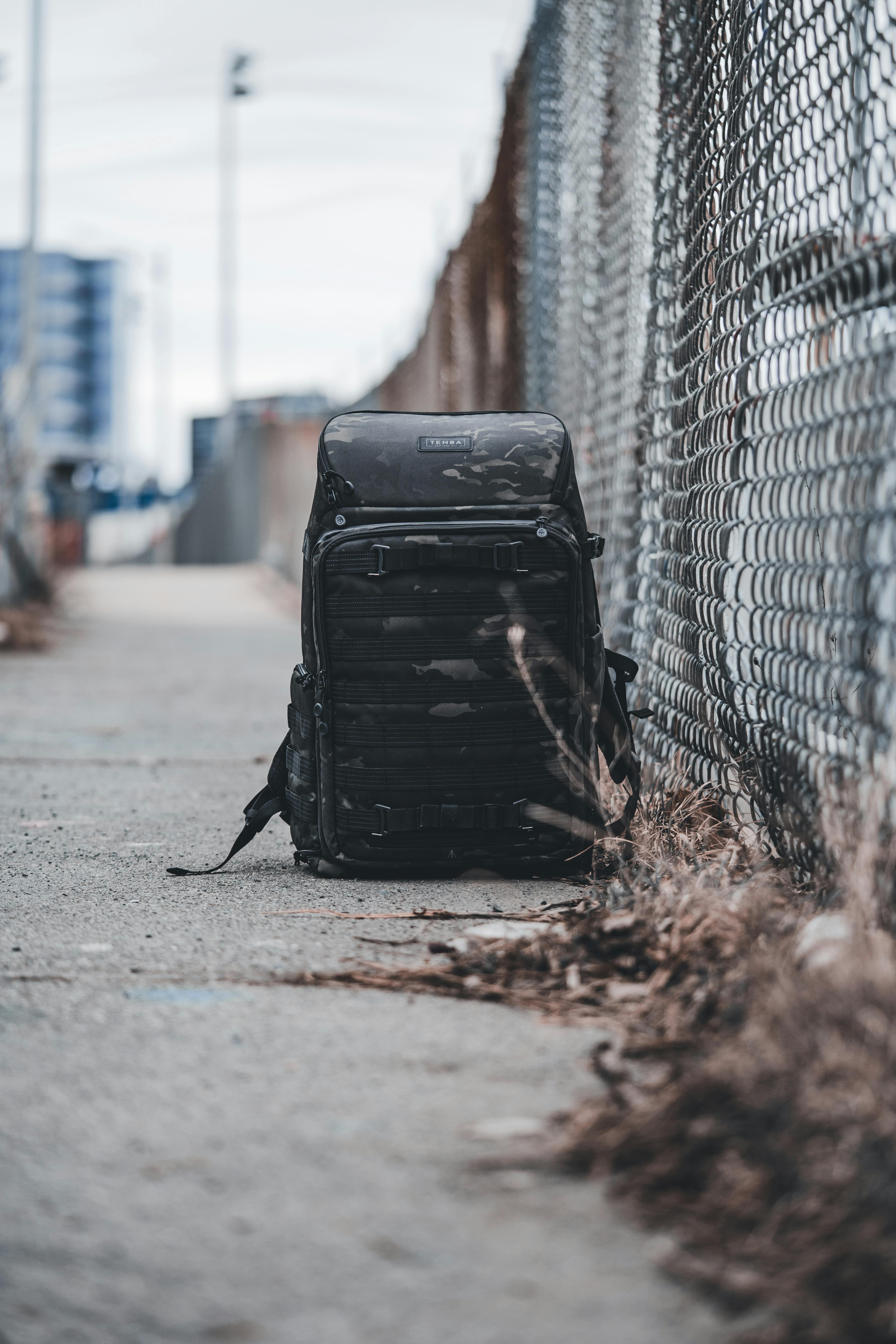 Black Backpack on the Sidewalk · Free Stock Photo