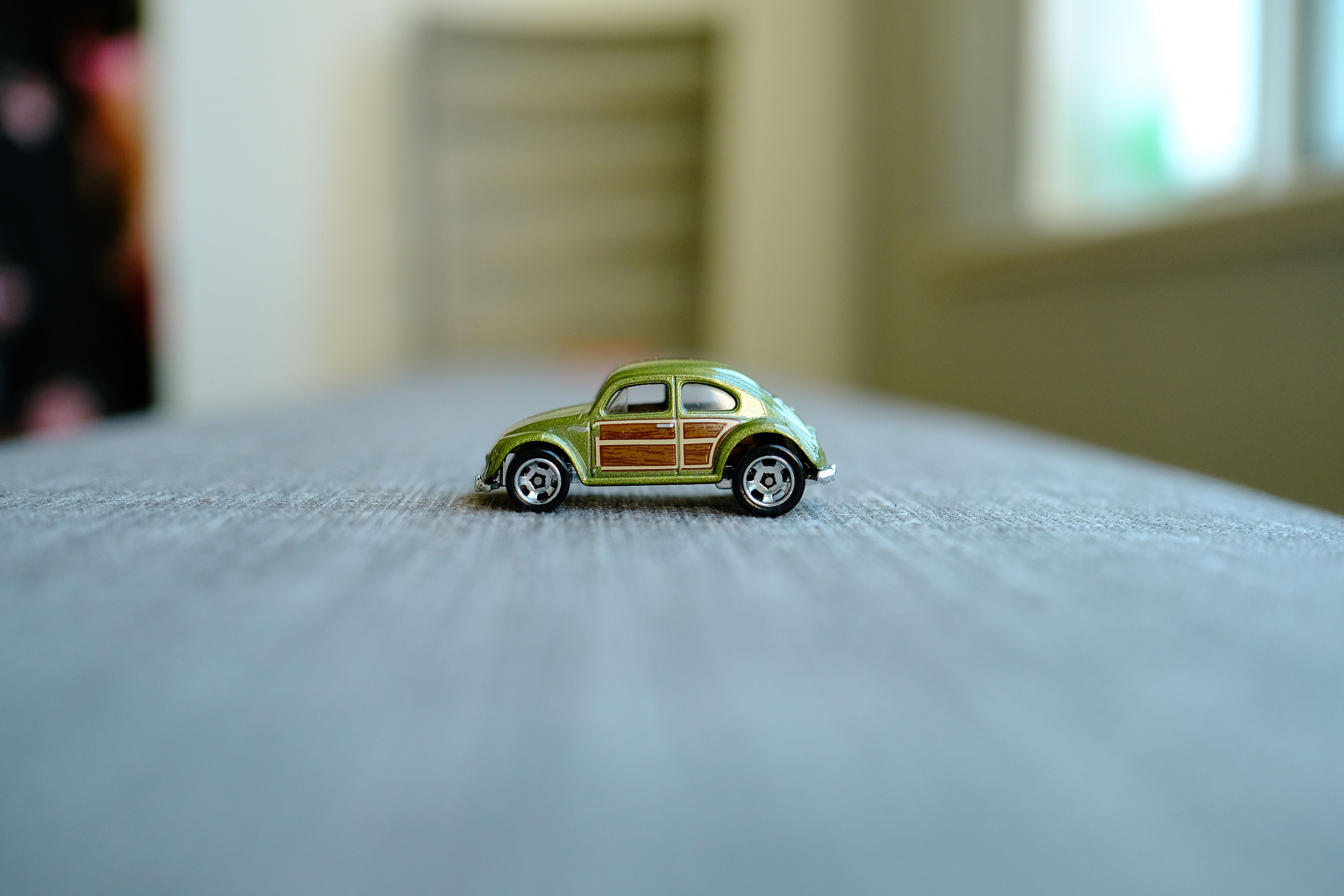 A toy car on a table in a room · Free Stock Photo