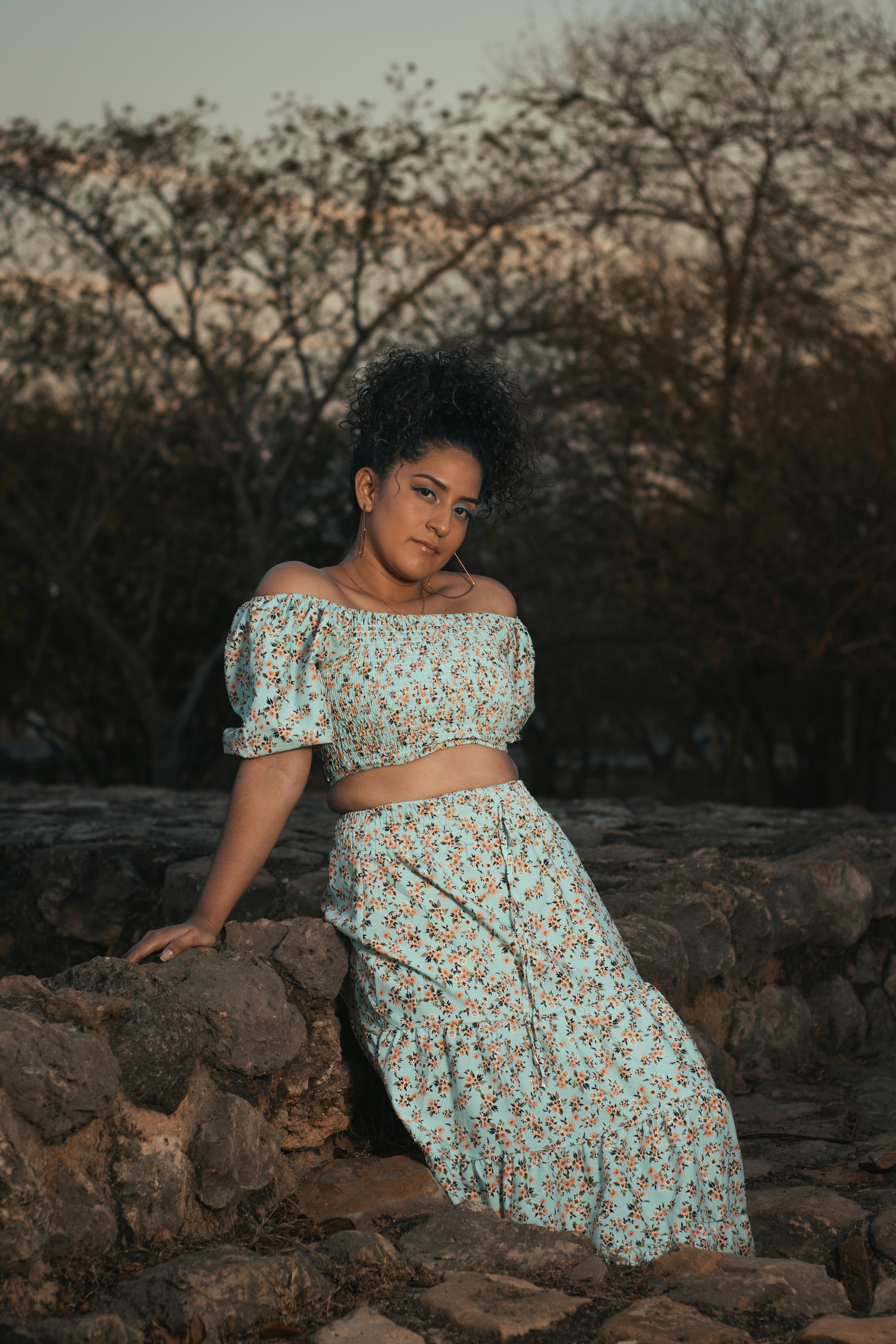 Pretty Woman Wearing Crop Top Leaning against a Low Wall · Free Stock Photo