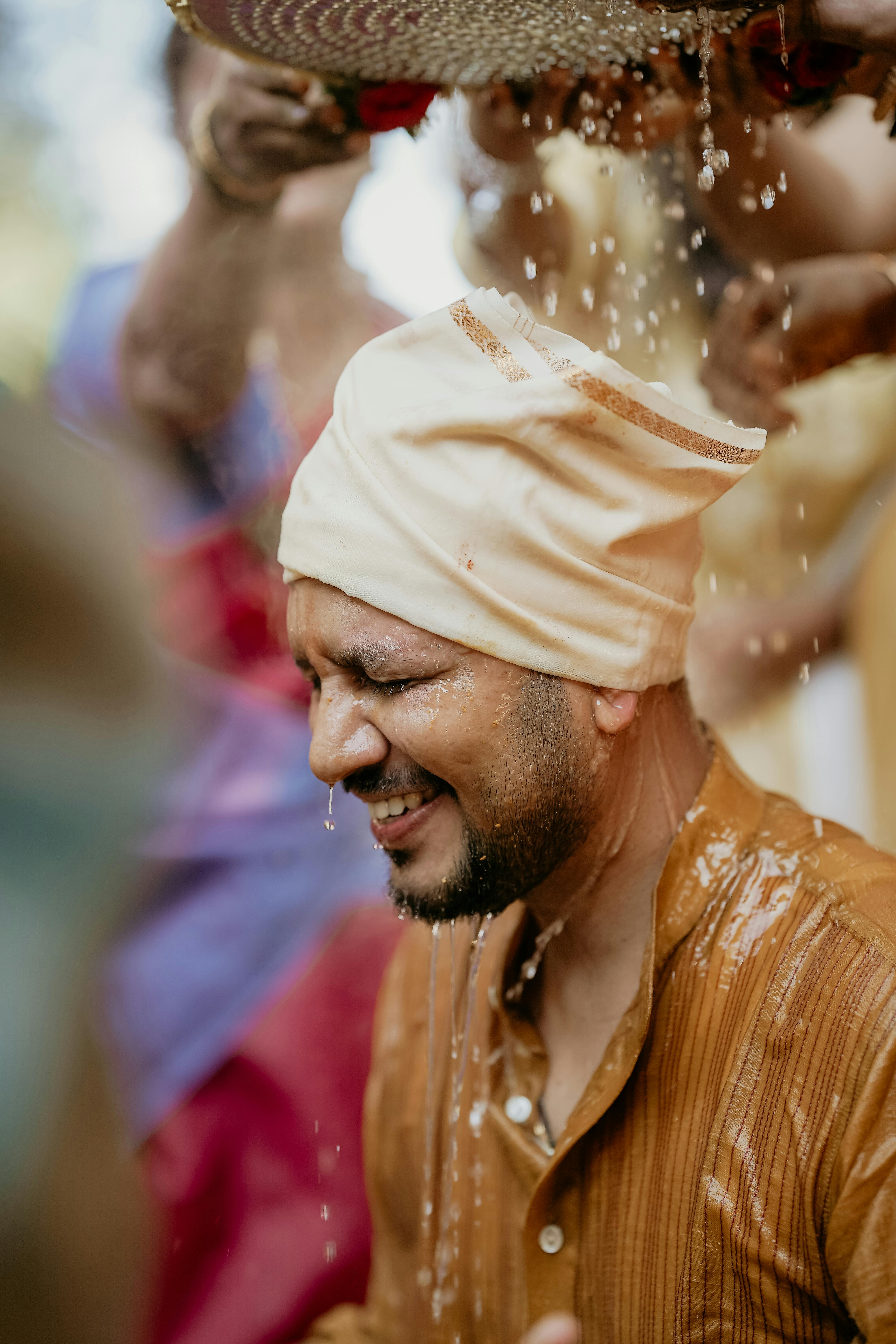 Indian Man Getting Water Poured on his Head · Free Stock Photo