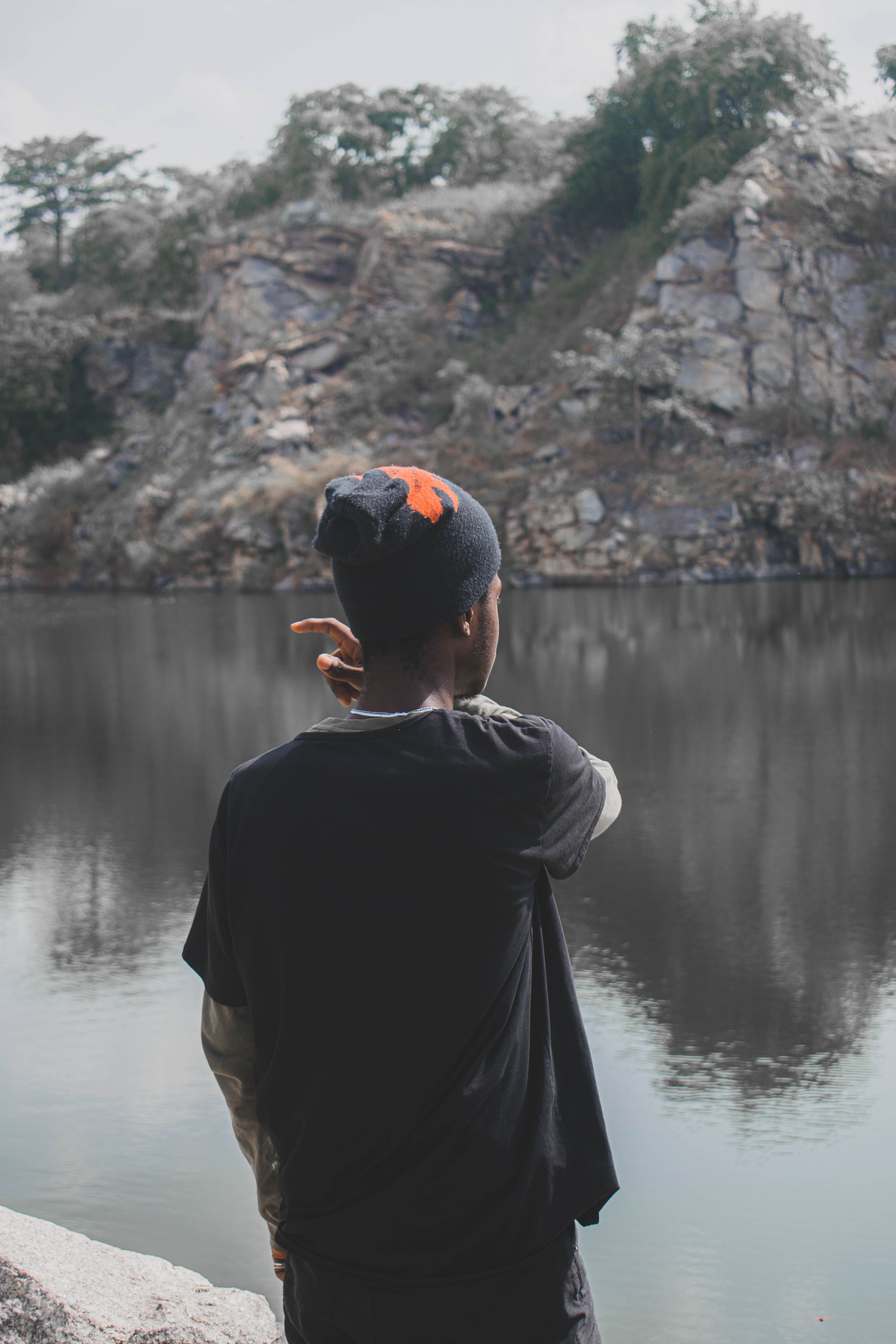 Back View of Black Man in Baseball Hat and T-Shirt · Free Stock Photo