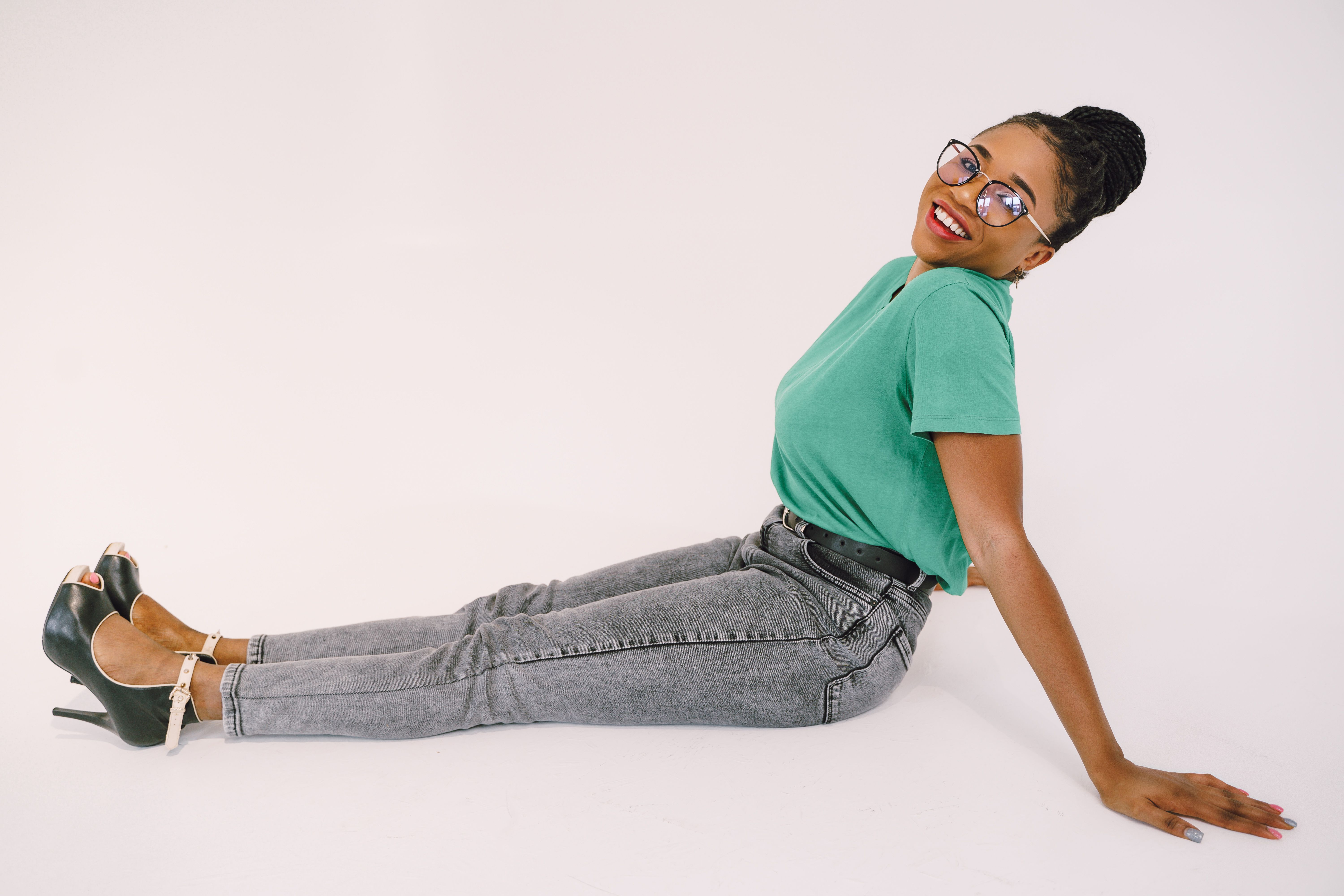 Smiling Model Sitting on the Floor with Her Legs Up in the Air · Free ...
