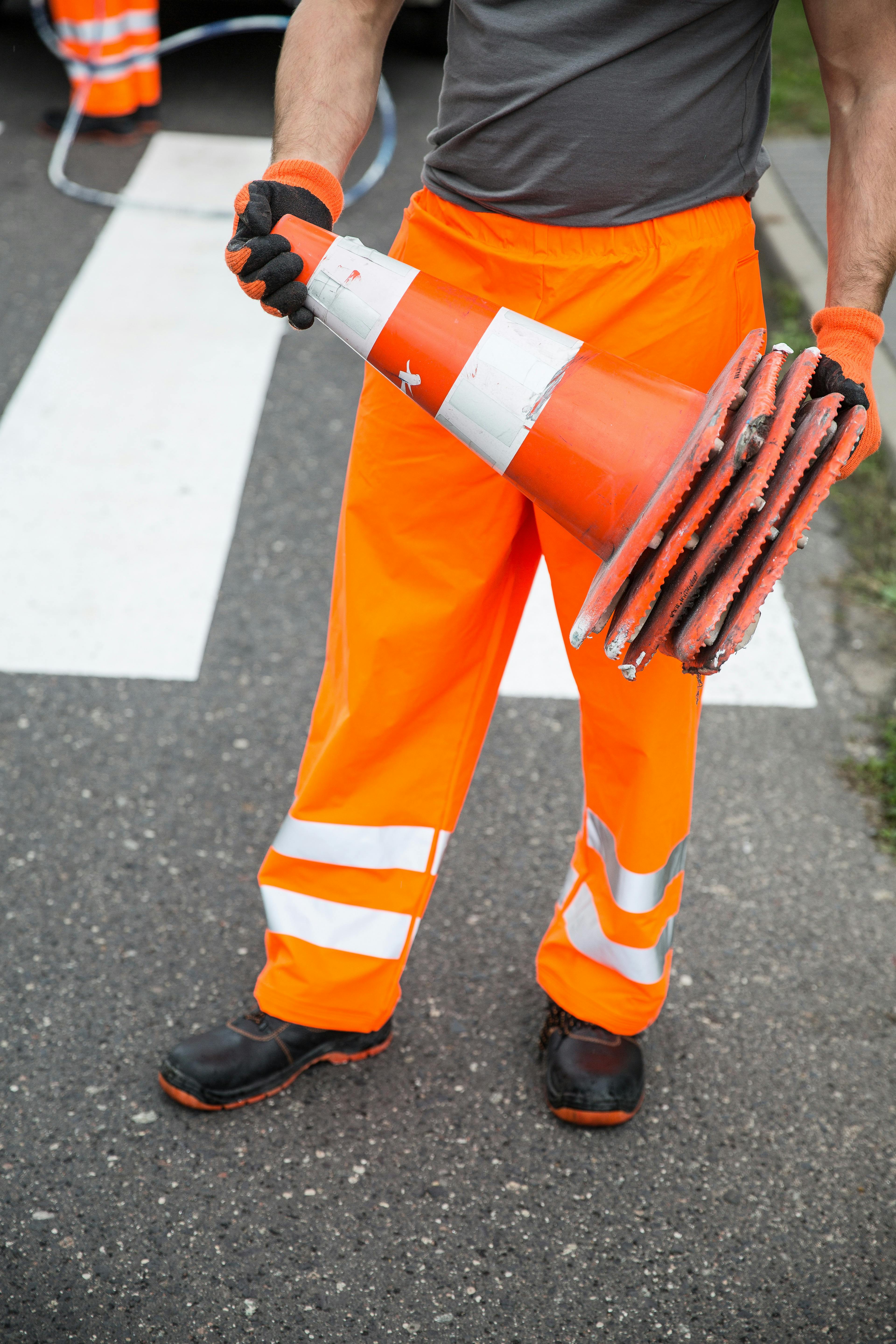 Worker Picking Up Traffic Cones · Free Stock Photo
