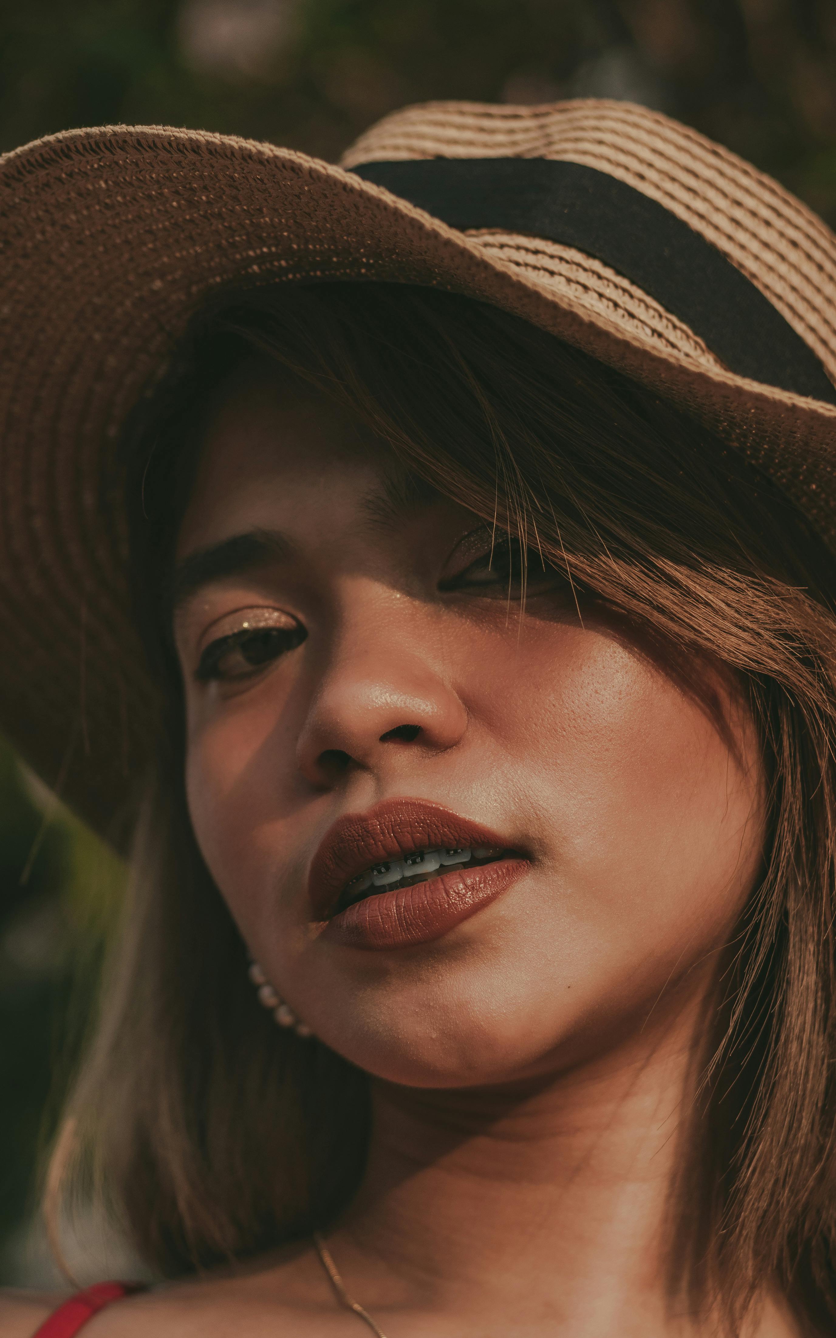 Sunlit Face of Woman in Hat · Free Stock Photo