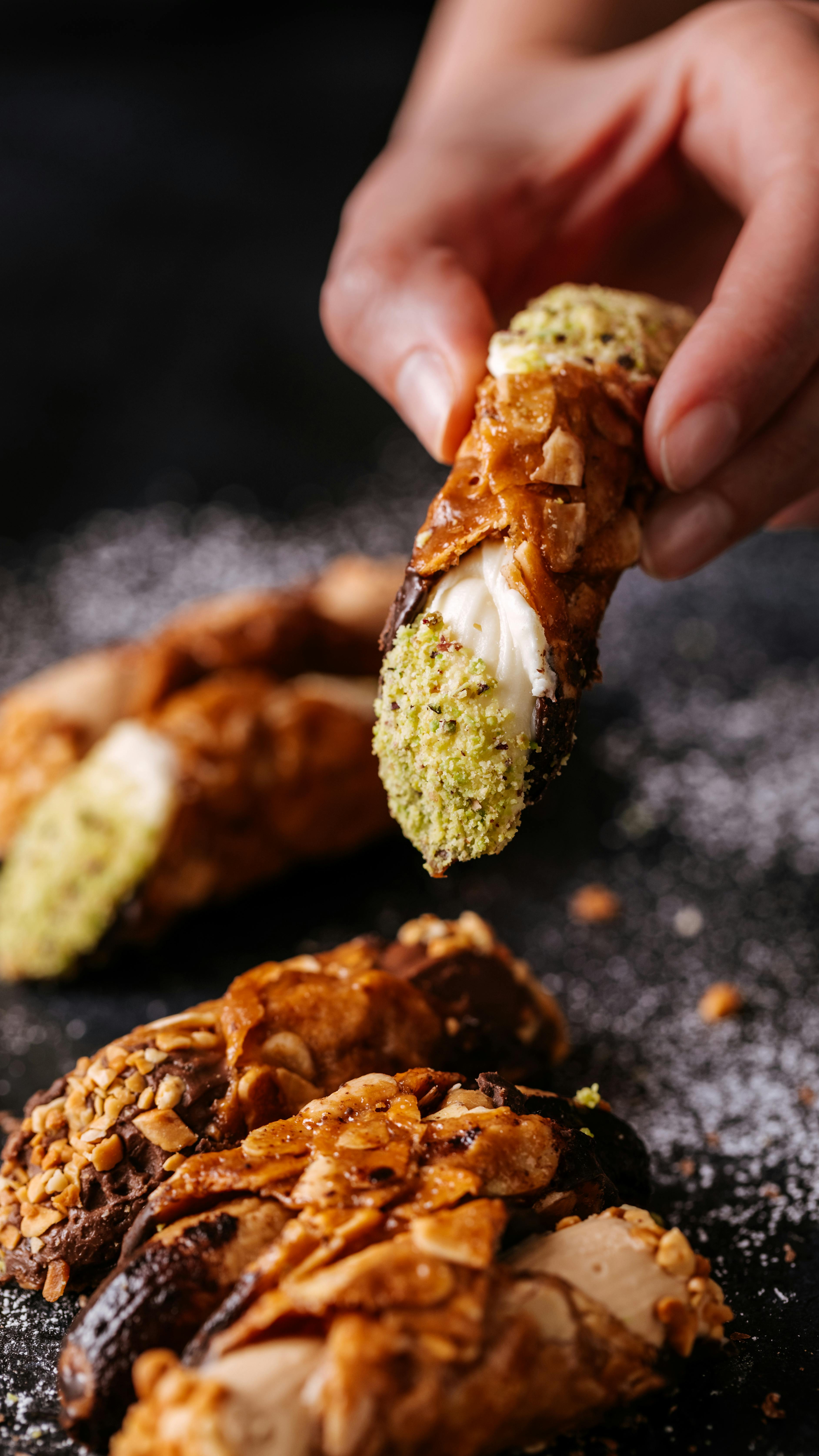 Hand Holding Snack with Cream · Free Stock Photo