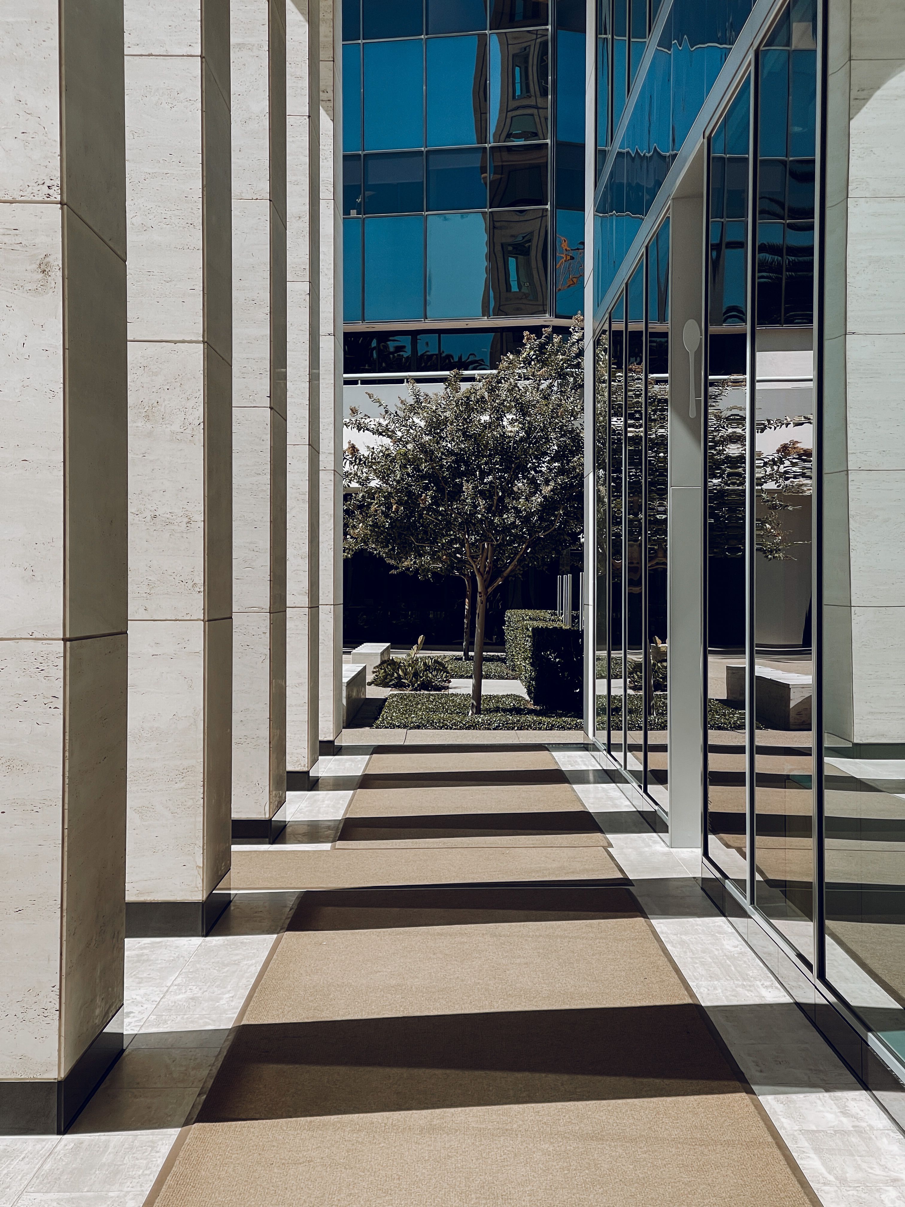 Pavement between a Glass Facade and Columns of a Modern Skyscraper ...